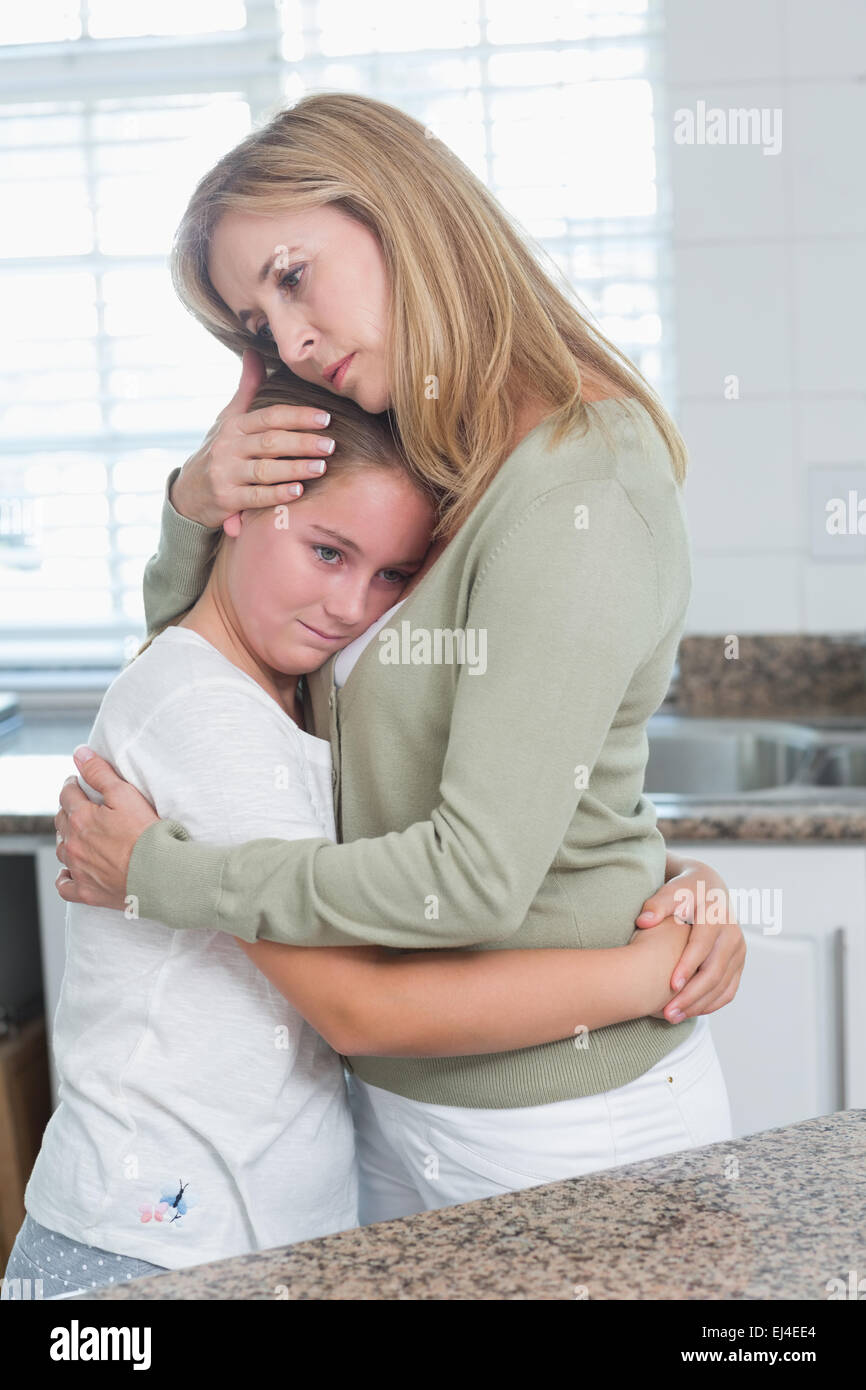 Sad little girl hugging her mother Stock Photo - Alamy