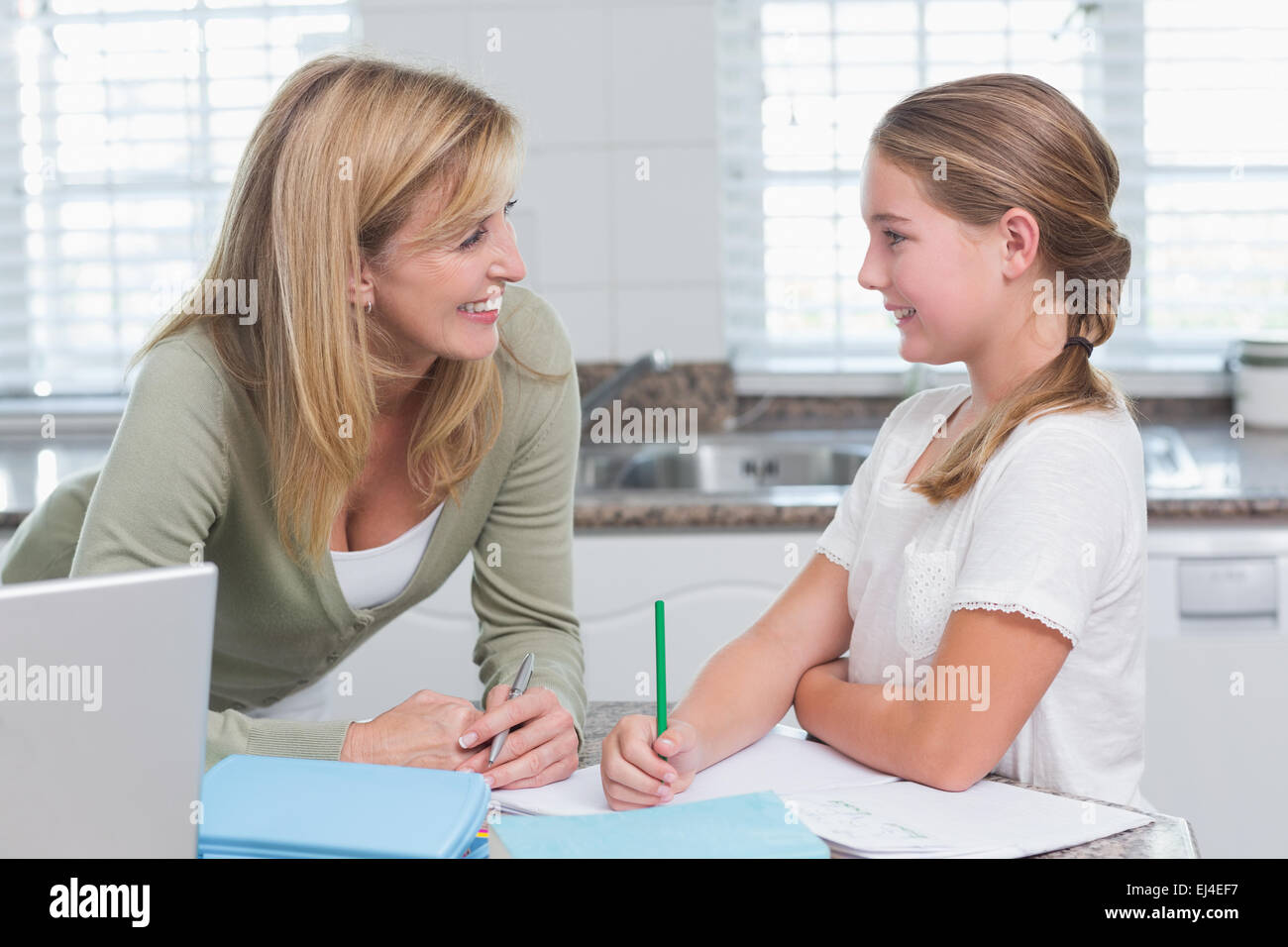 Woman daughter doing homework together hi-res stock photography and ...