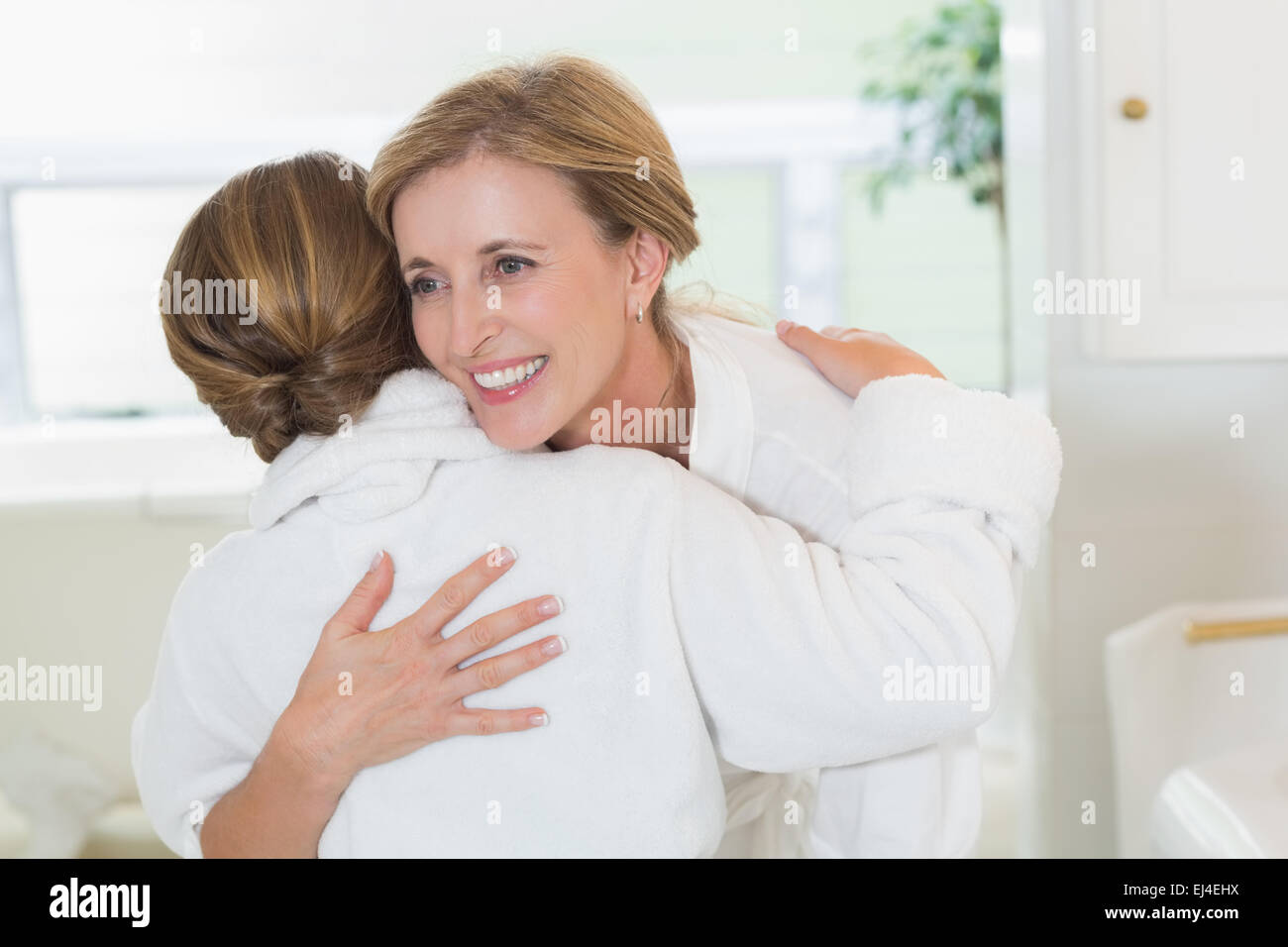 Happy mother and daughter hugging Stock Photo - Alamy