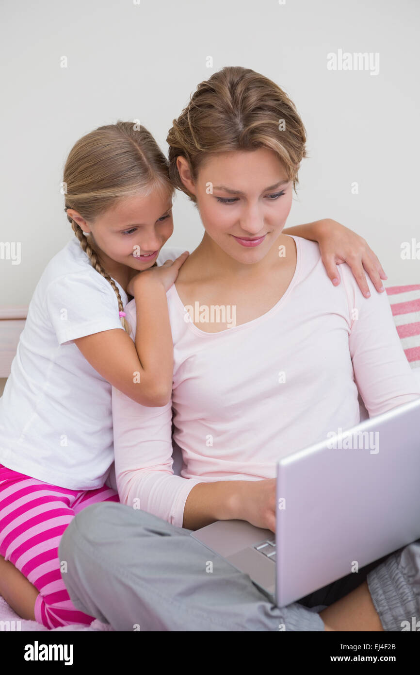 Mother and daughter using laptop in bed Stock Photo - Alamy