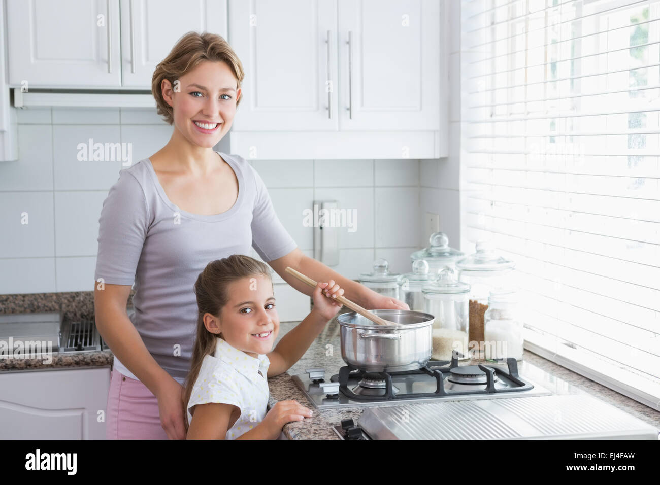 Mother and daughter cooking together Stock Photo - Alamy