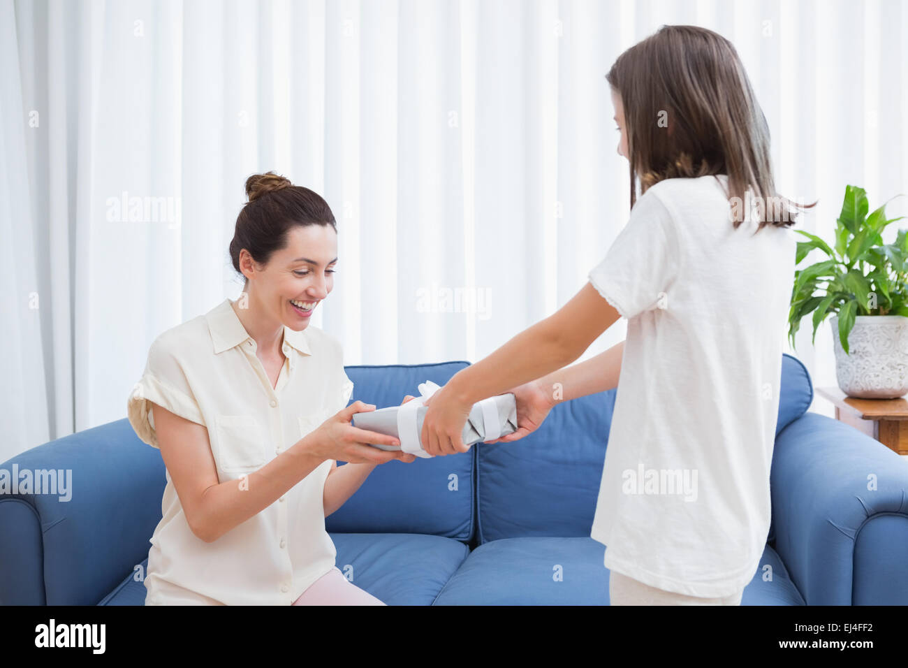 Daughter giving her mother a present Stock Photo - Alamy