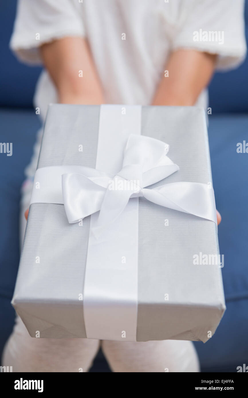 Hands offering a silver gift Stock Photo - Alamy