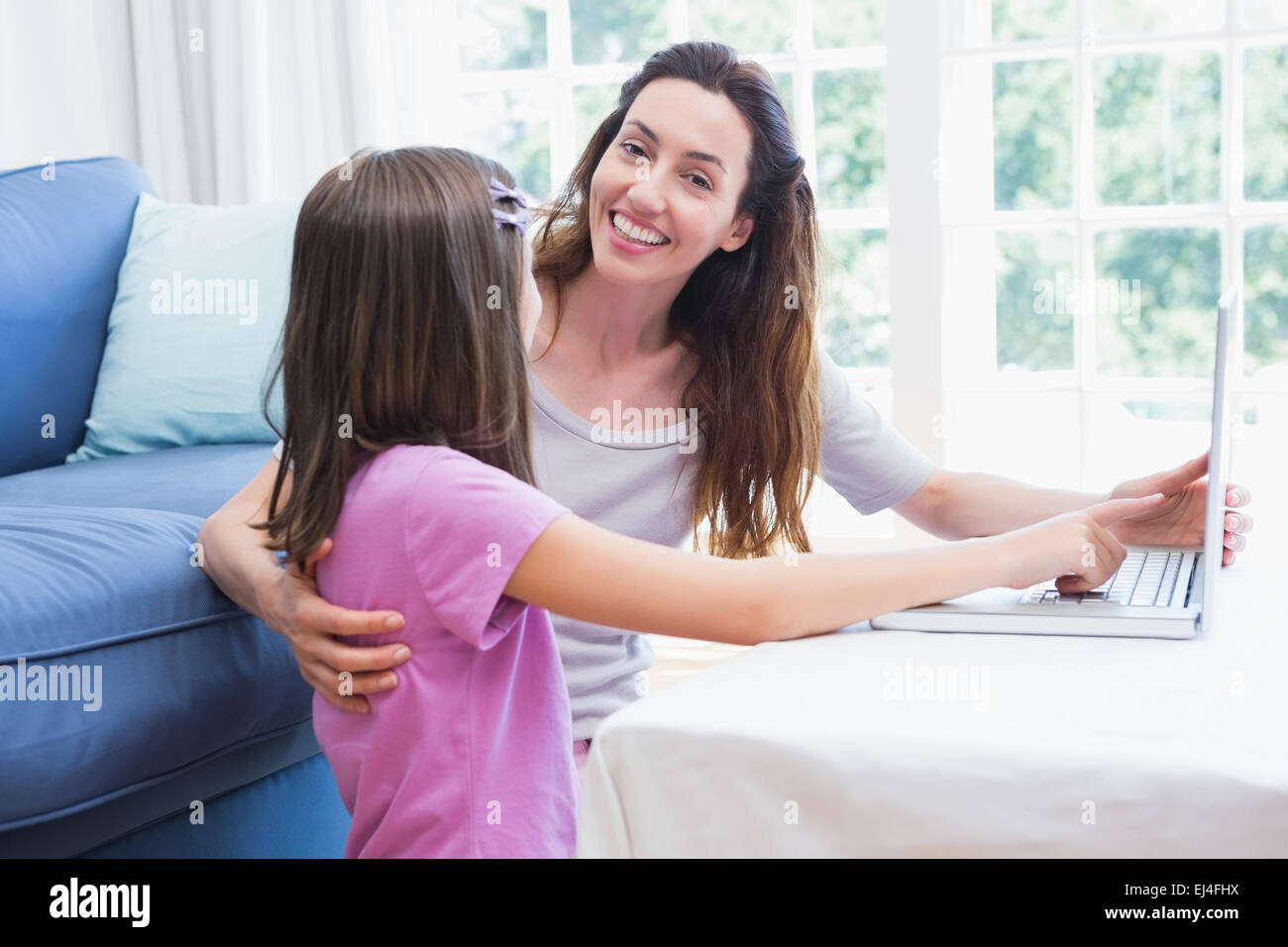Mother and daughter using laptop Stock Photo - Alamy