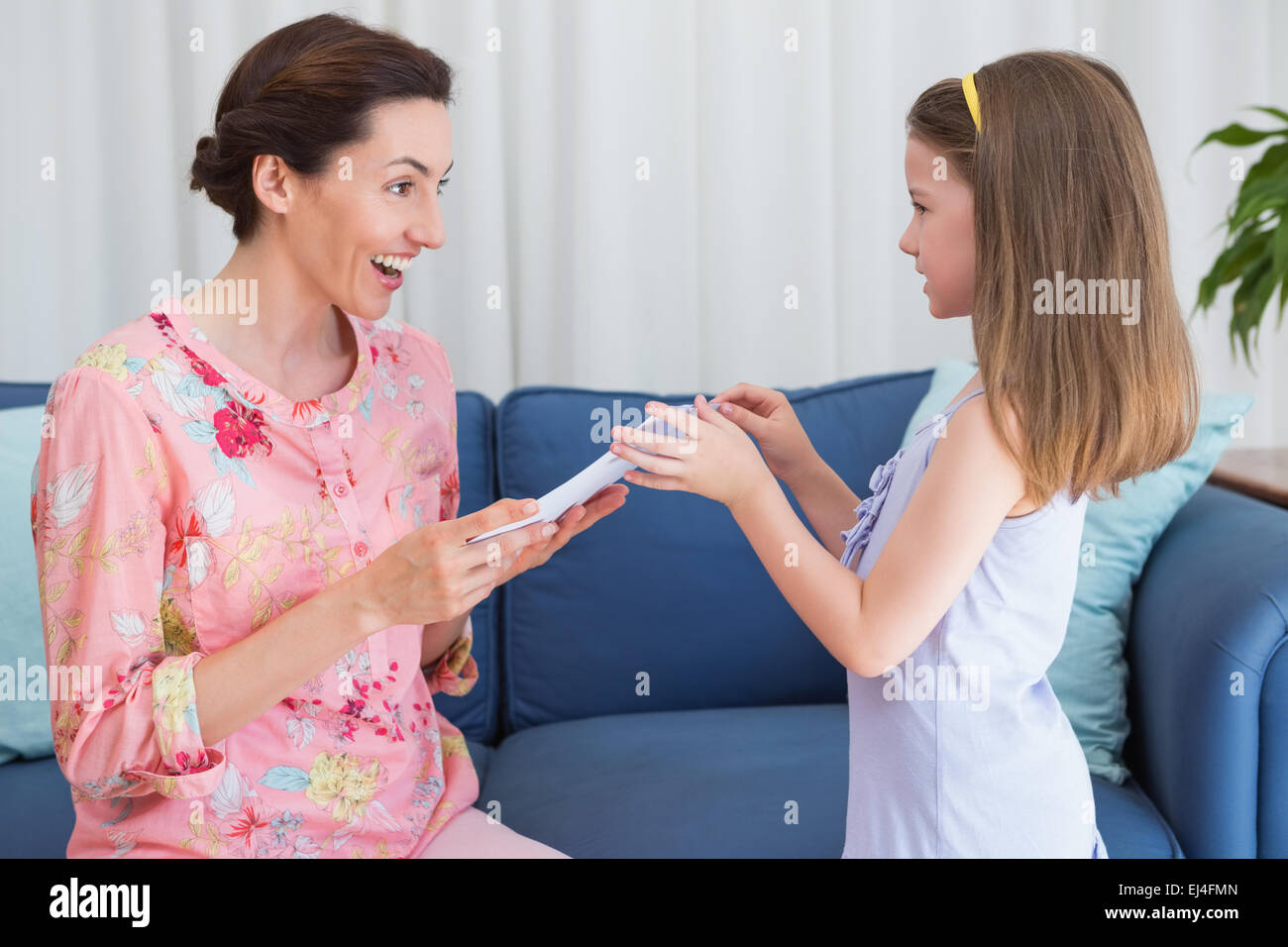 Little girl giving her mother a gift Stock Photo - Alamy