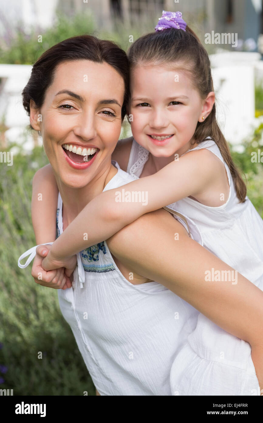 Mother and daughter smiling at camera Stock Photo - Alamy