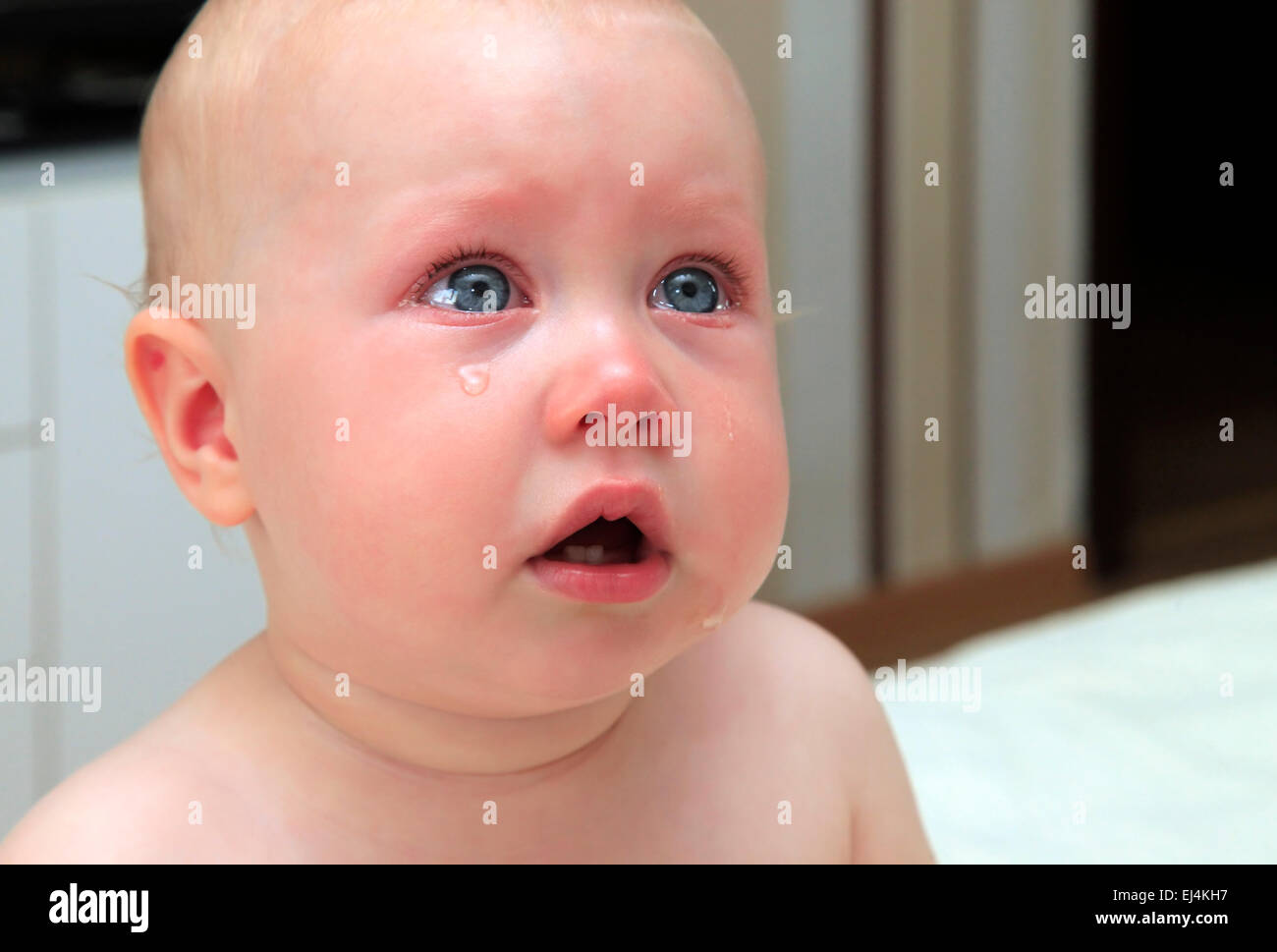 Beautiful sad little girl at home Stock Photo - Alamy