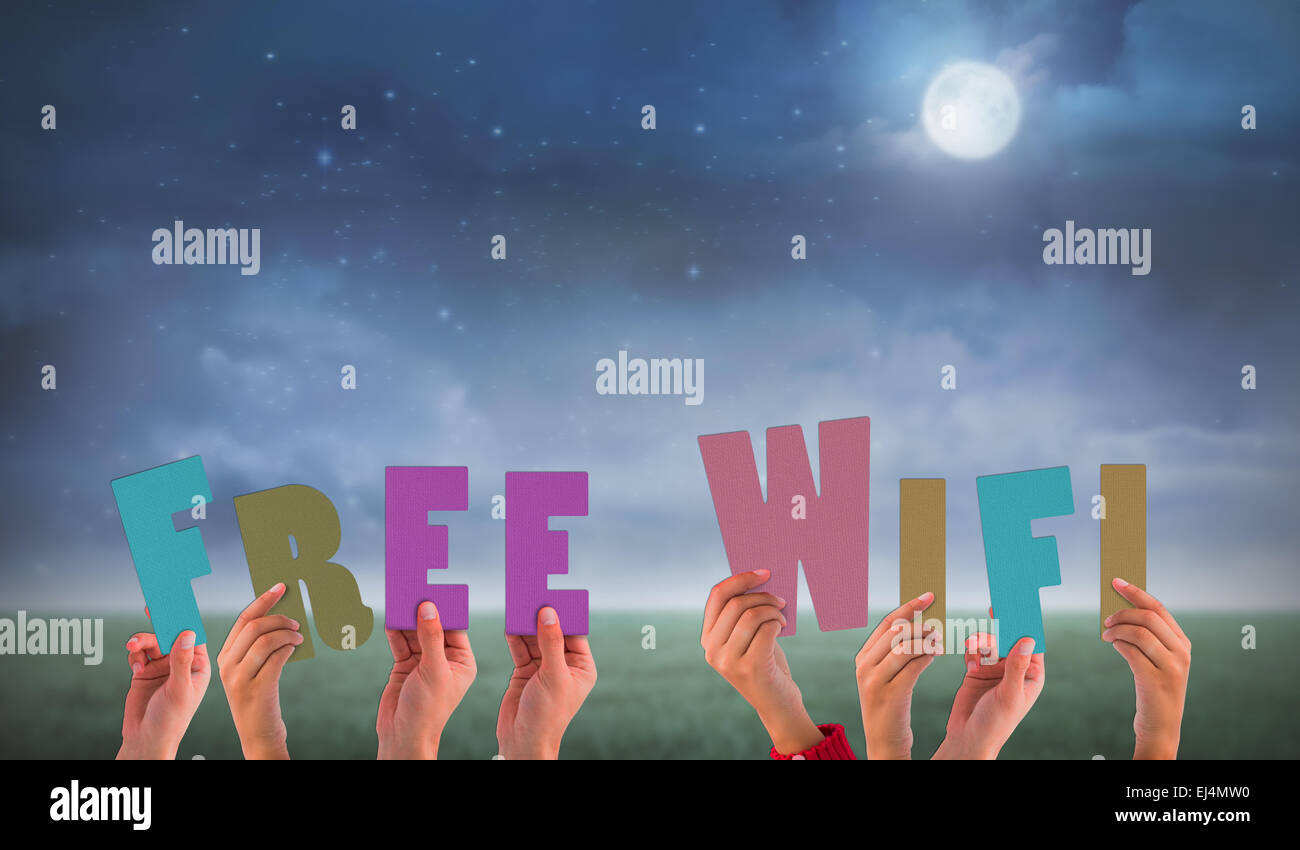 Composite image of hands holding up free wifi Stock Photo - Alamy