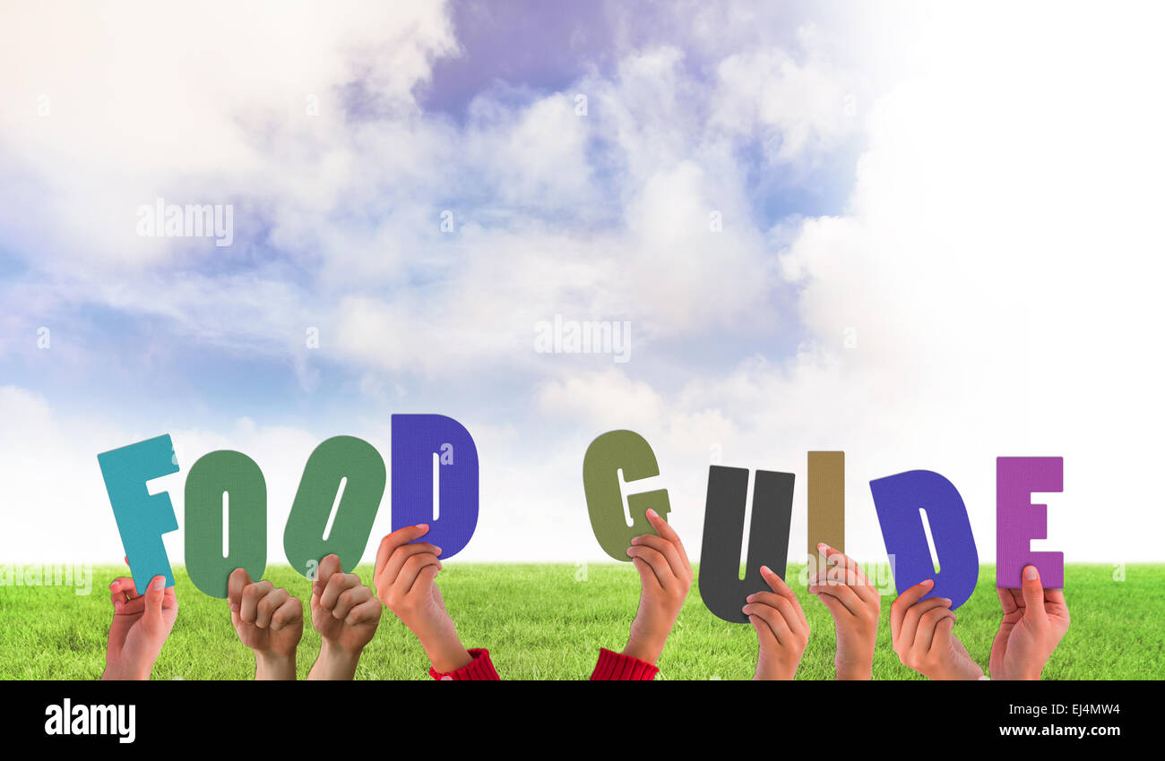 Composite image of hands holding up food guide Stock Photo - Alamy