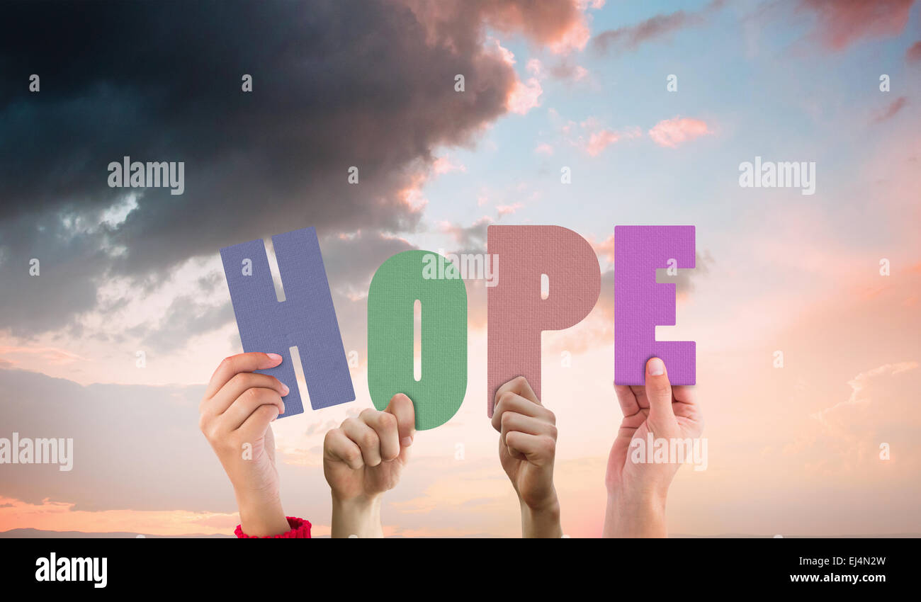 Composite image of hands holding up hope Stock Photo - Alamy