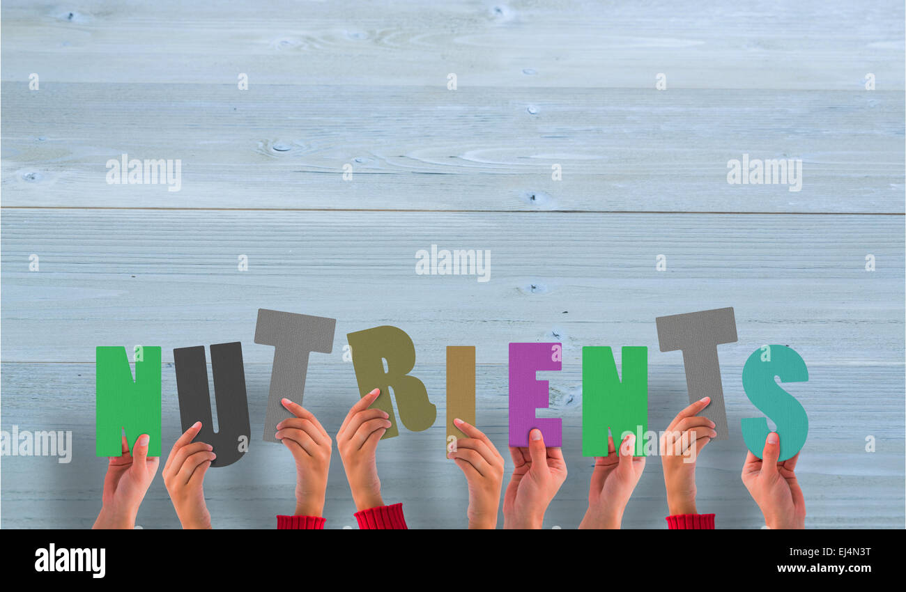 Composite image of hands holding up nutrients Stock Photo - Alamy