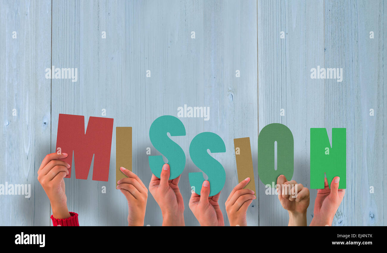 Composite image of hands holding up mission Stock Photo - Alamy