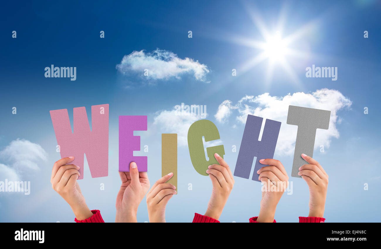 Composite image of hands holding up weight Stock Photo - Alamy