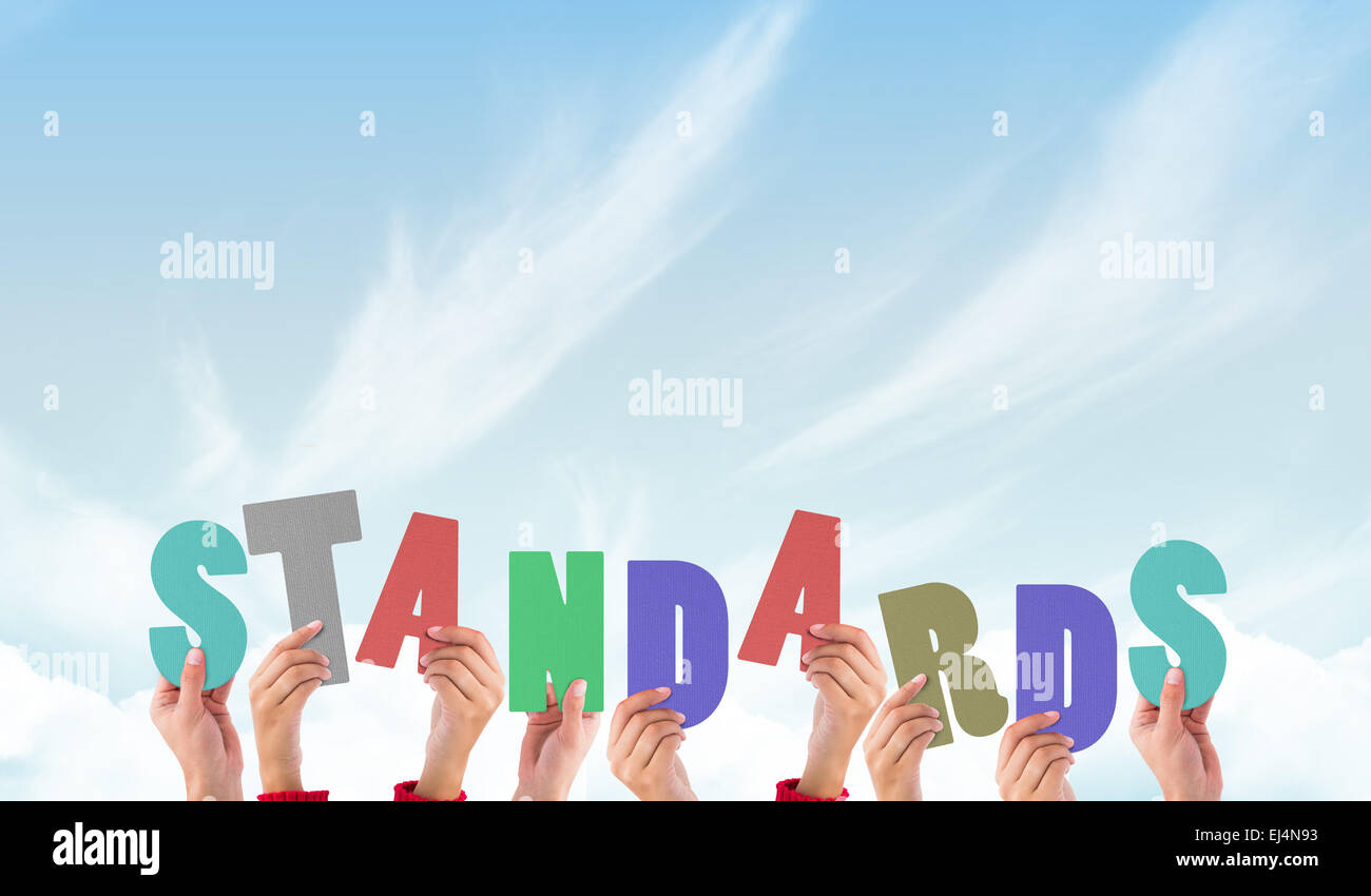 Composite image of hands holding up standards Stock Photo - Alamy