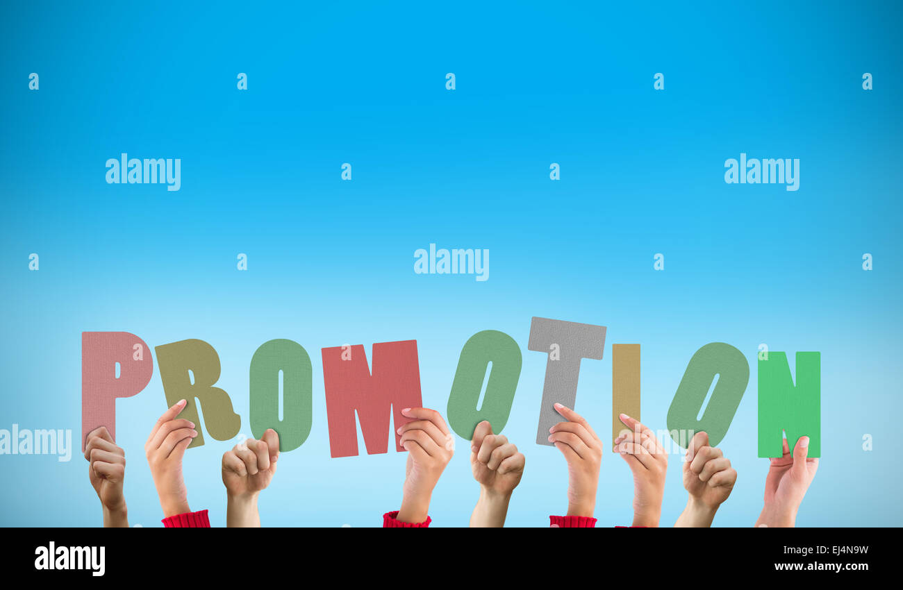 Composite image of hands holding up promotion Stock Photo - Alamy