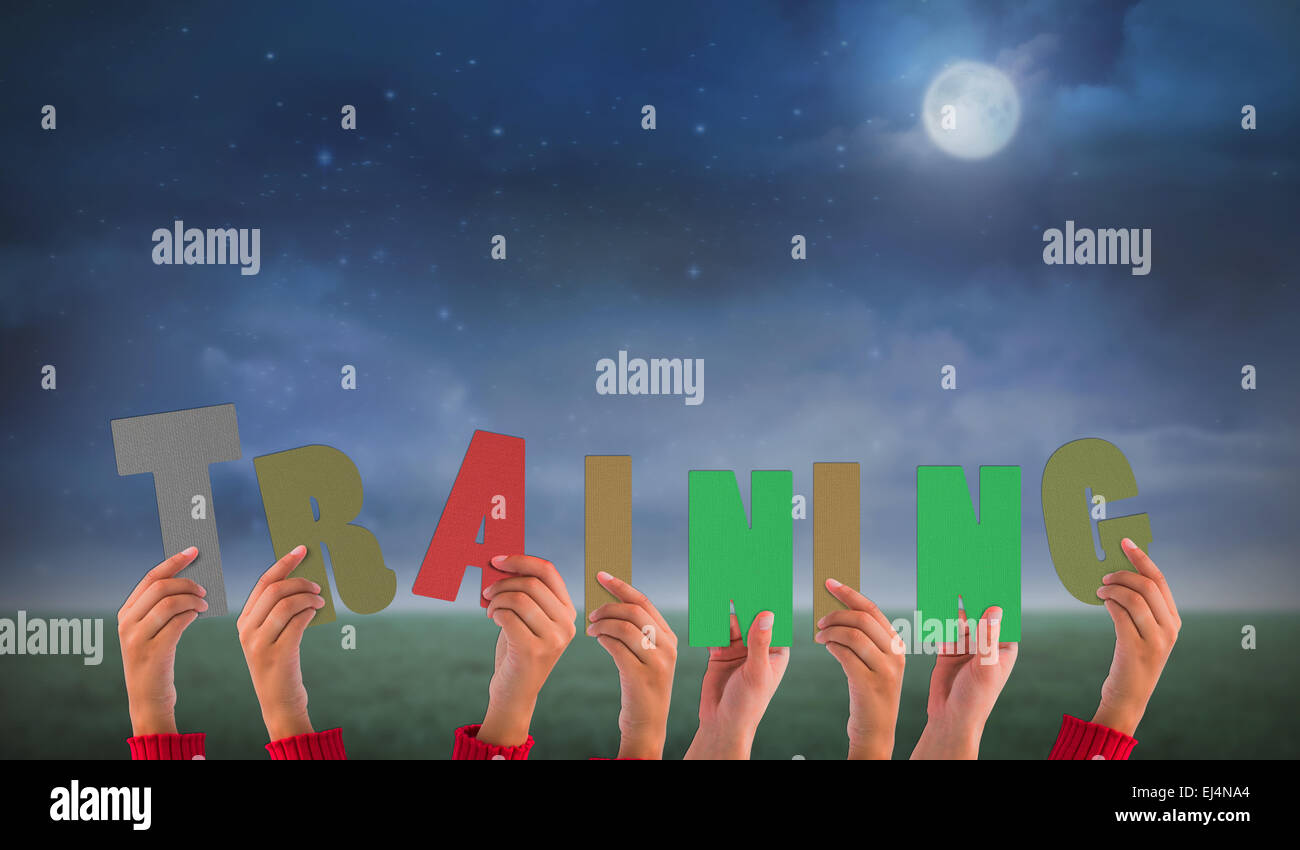Composite image of hands holding up training Stock Photo - Alamy