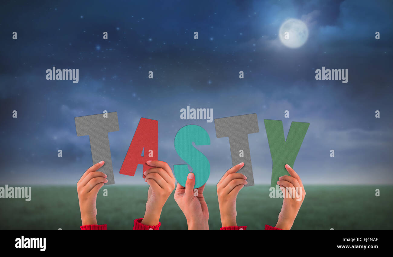 Composite image of hands holding up tasty Stock Photo - Alamy