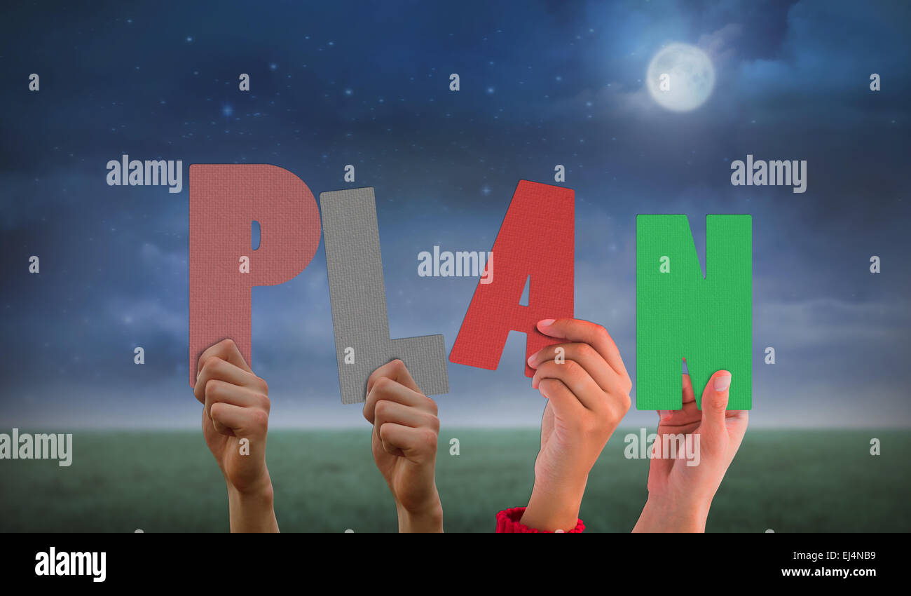Composite image of hands holding up plan Stock Photo - Alamy