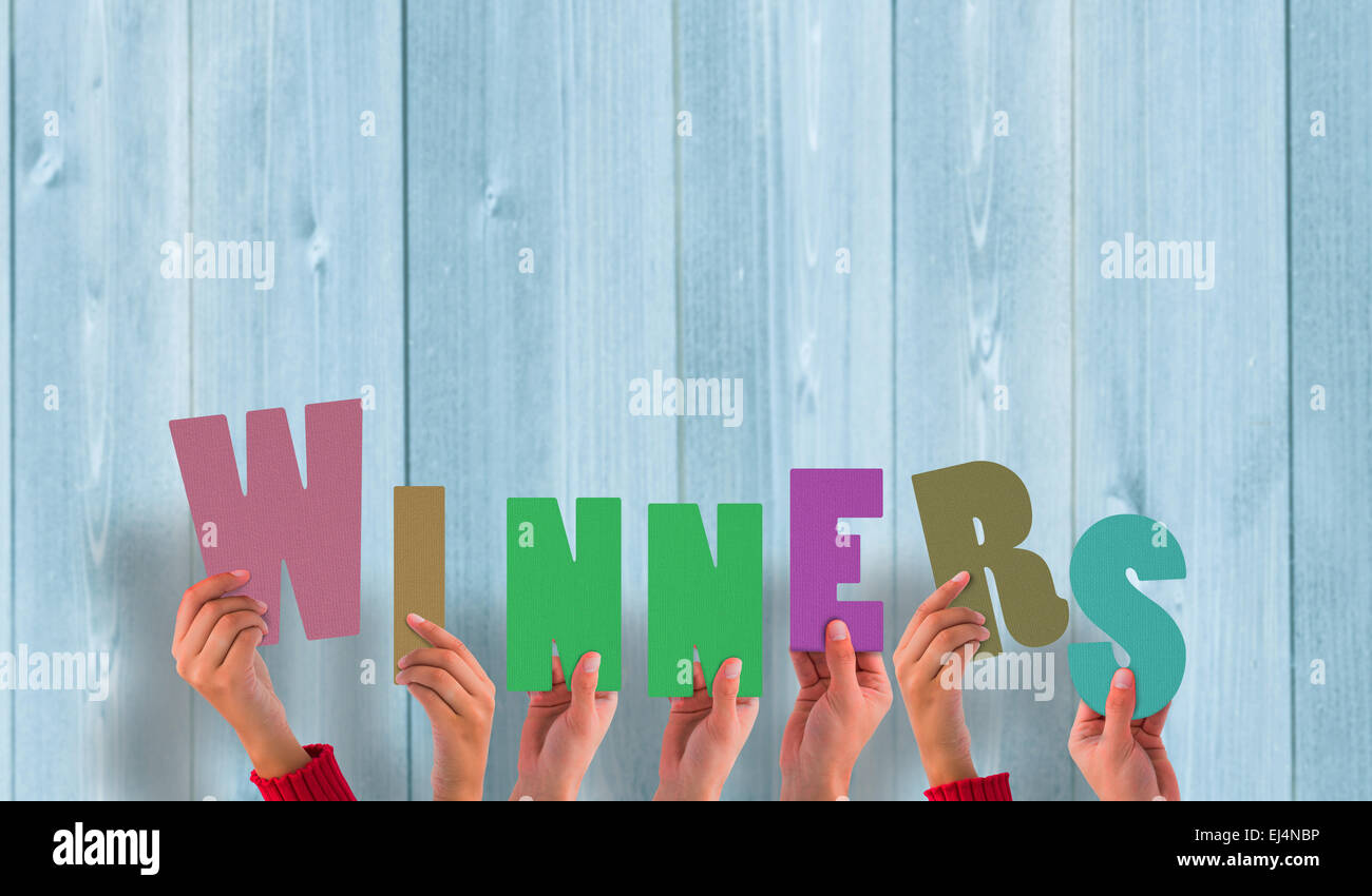 Composite image of hands holding up winners Stock Photo - Alamy