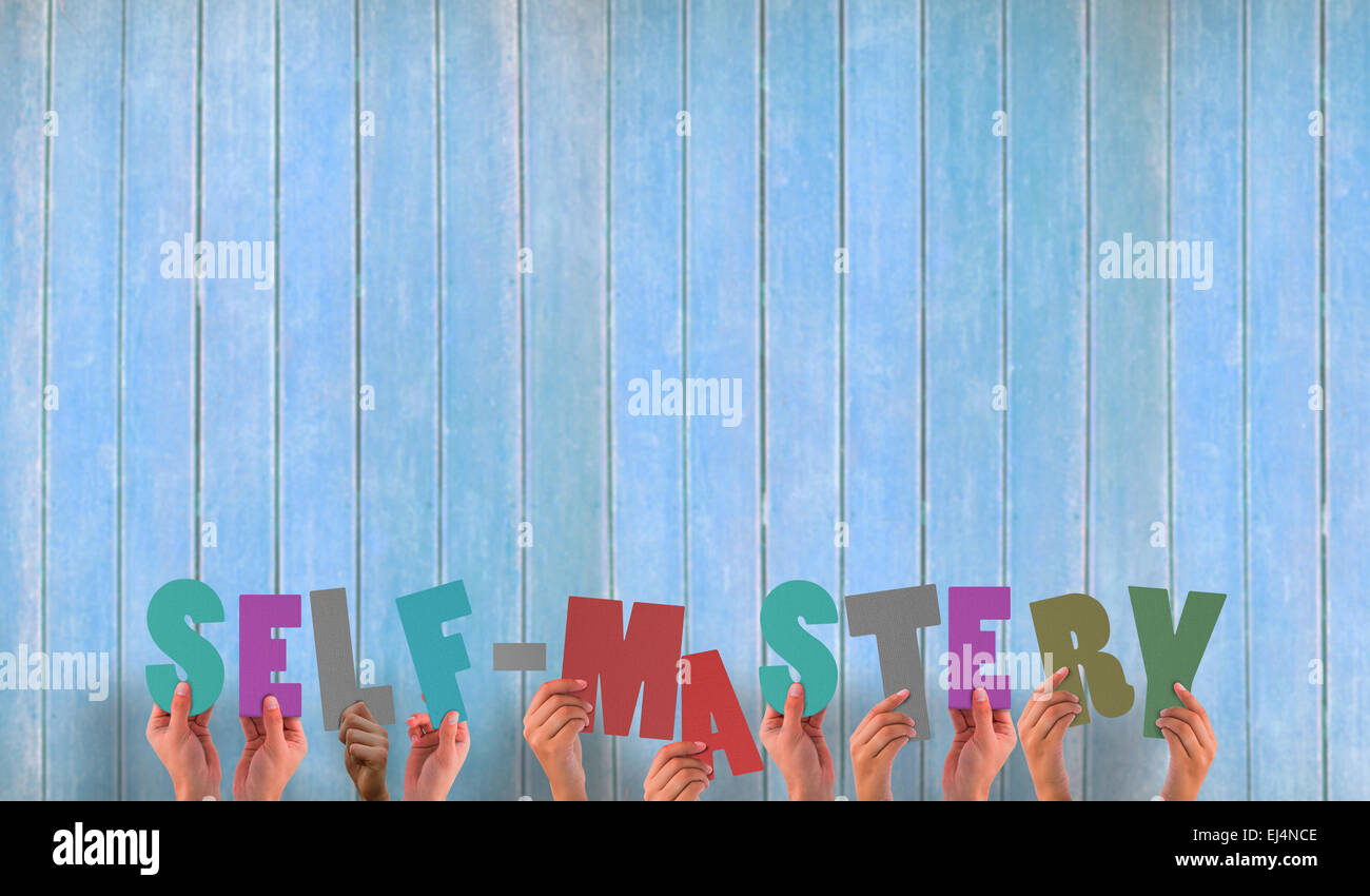 Composite image of hands holding up self mastery Stock Photo - Alamy