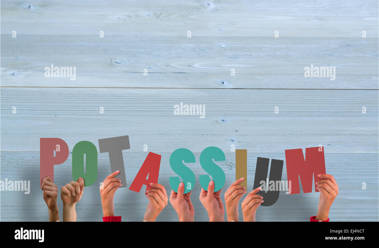 Composite image of hands holding up potassium Stock Photo - Alamy