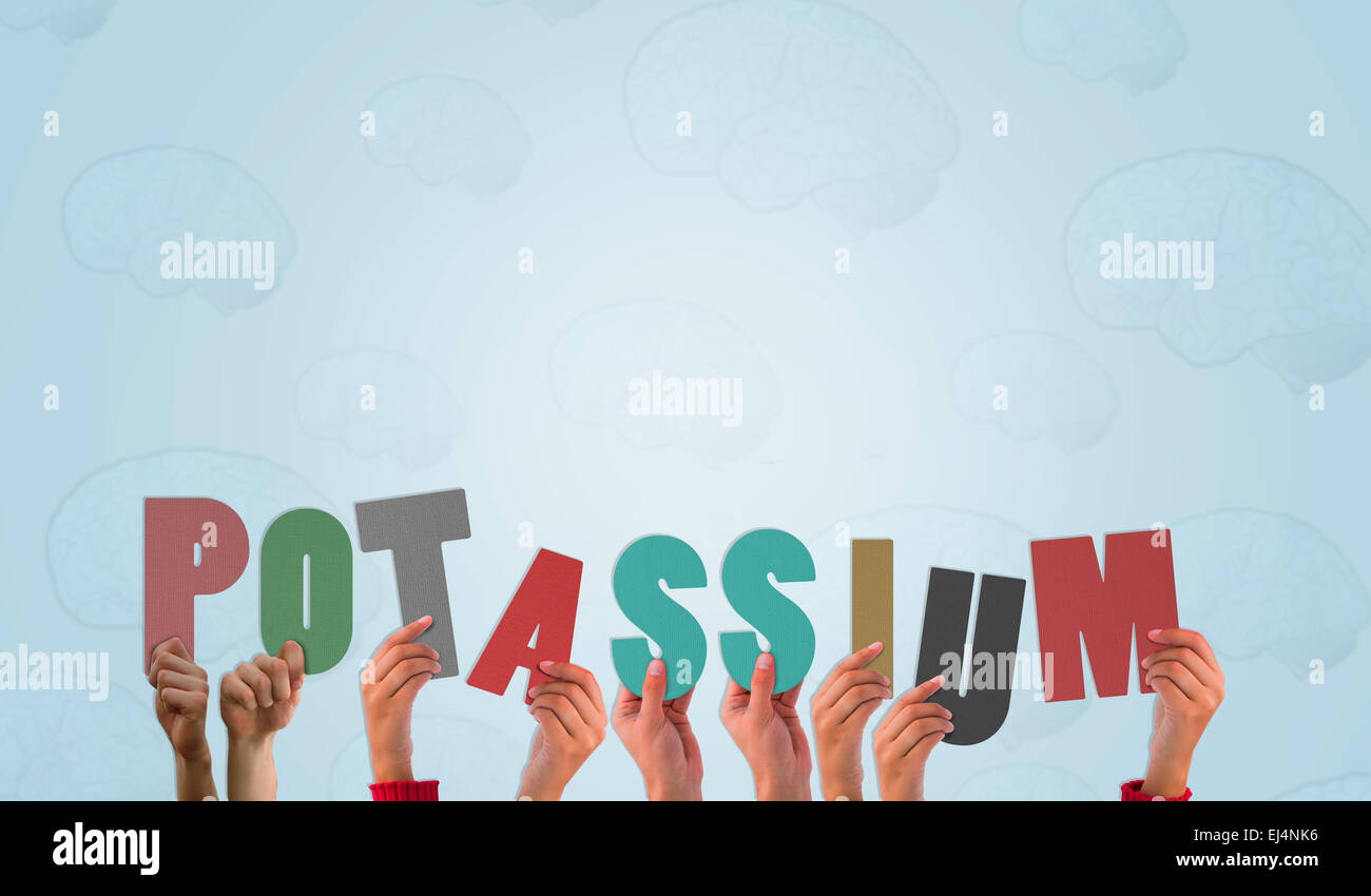 Composite image of hands holding up potassium Stock Photo - Alamy