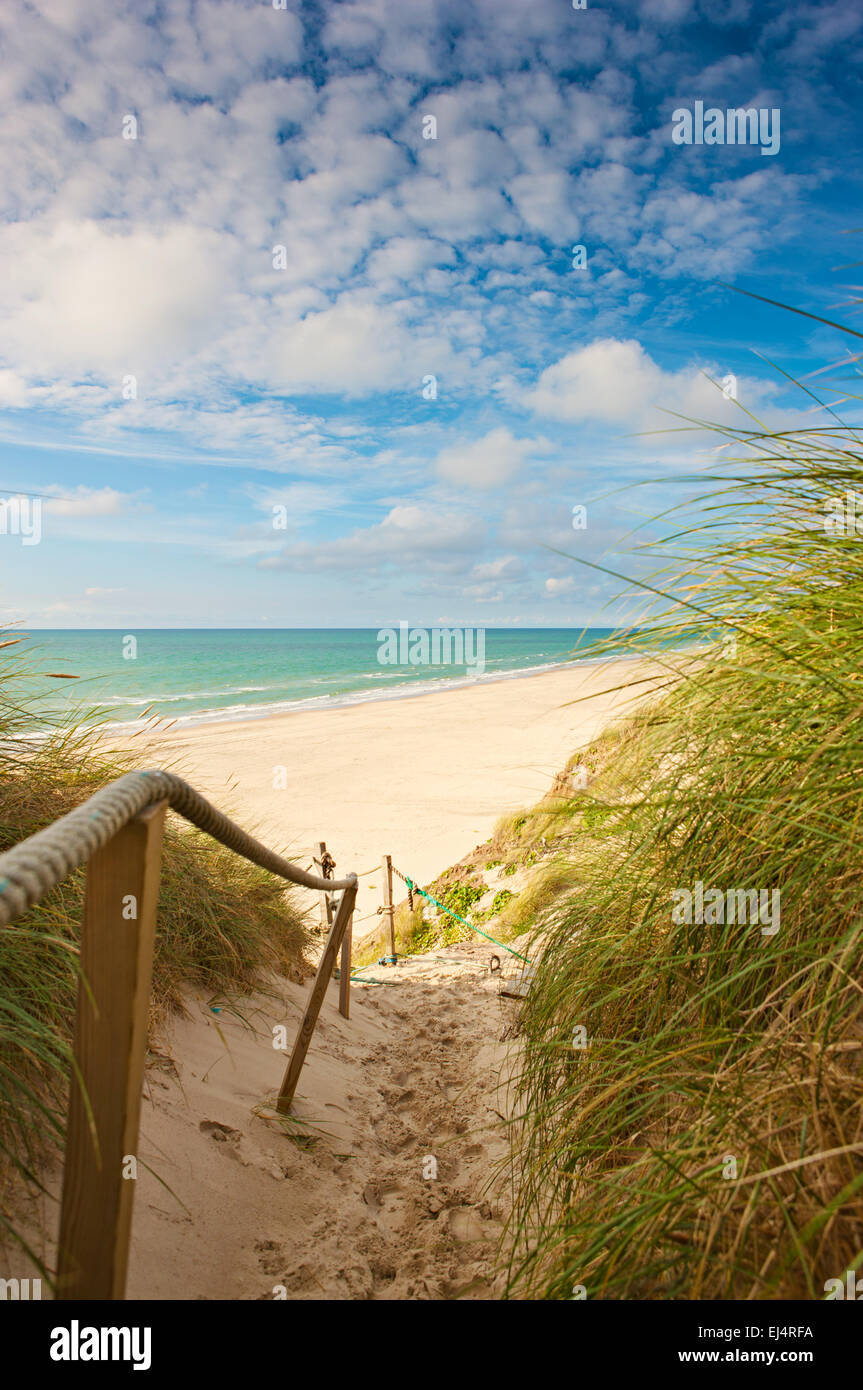 Seaside with sand dunes and colorful sky Stock Photo - Alamy