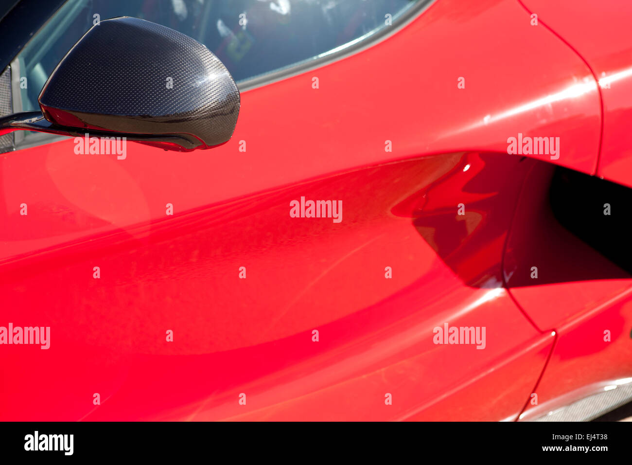 Red sports car wing mirror. Detail of a luxury car Stock Photo - Alamy