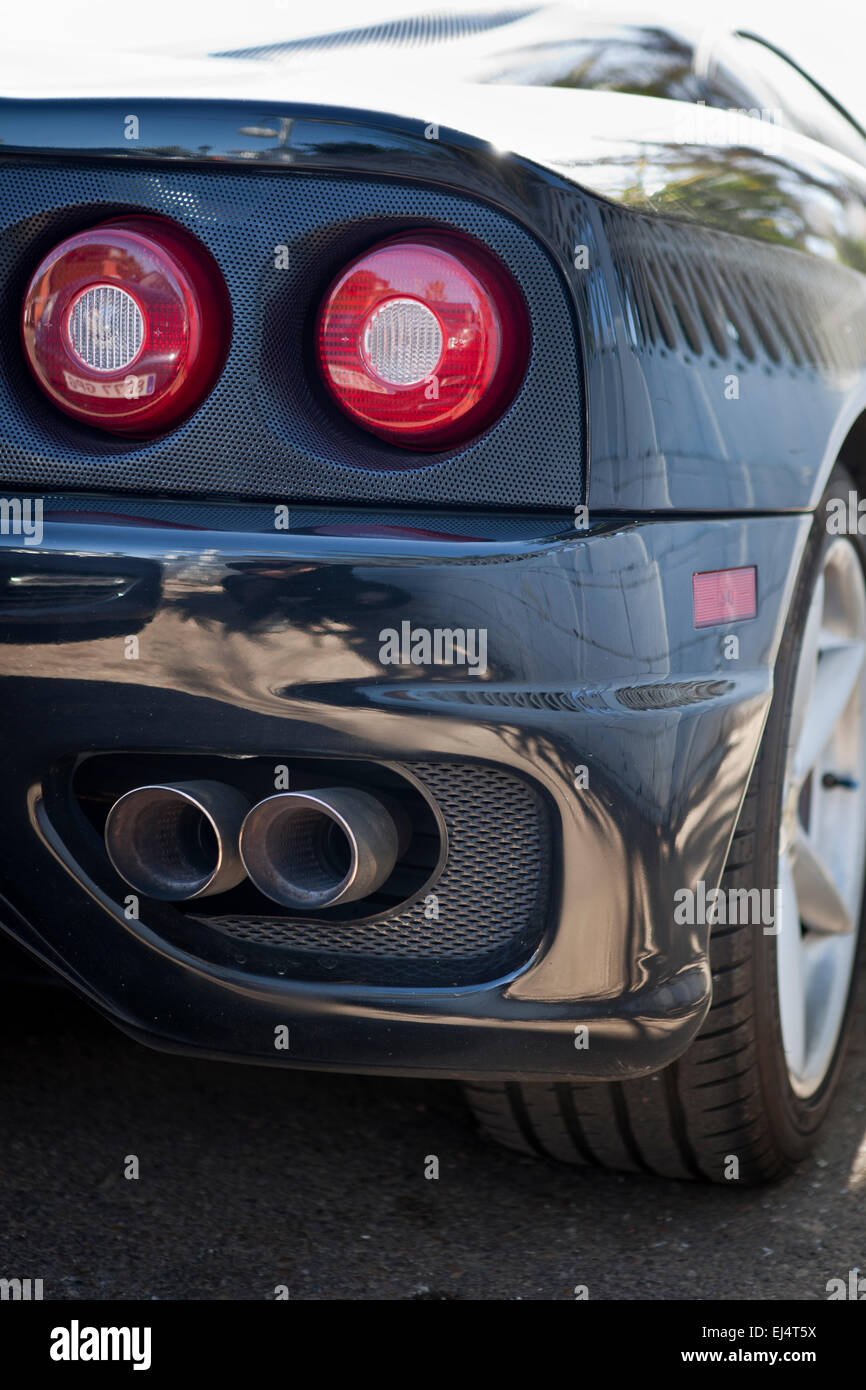 Black sports car spot lights and exhaust pipe. Detail of a luxury car ...