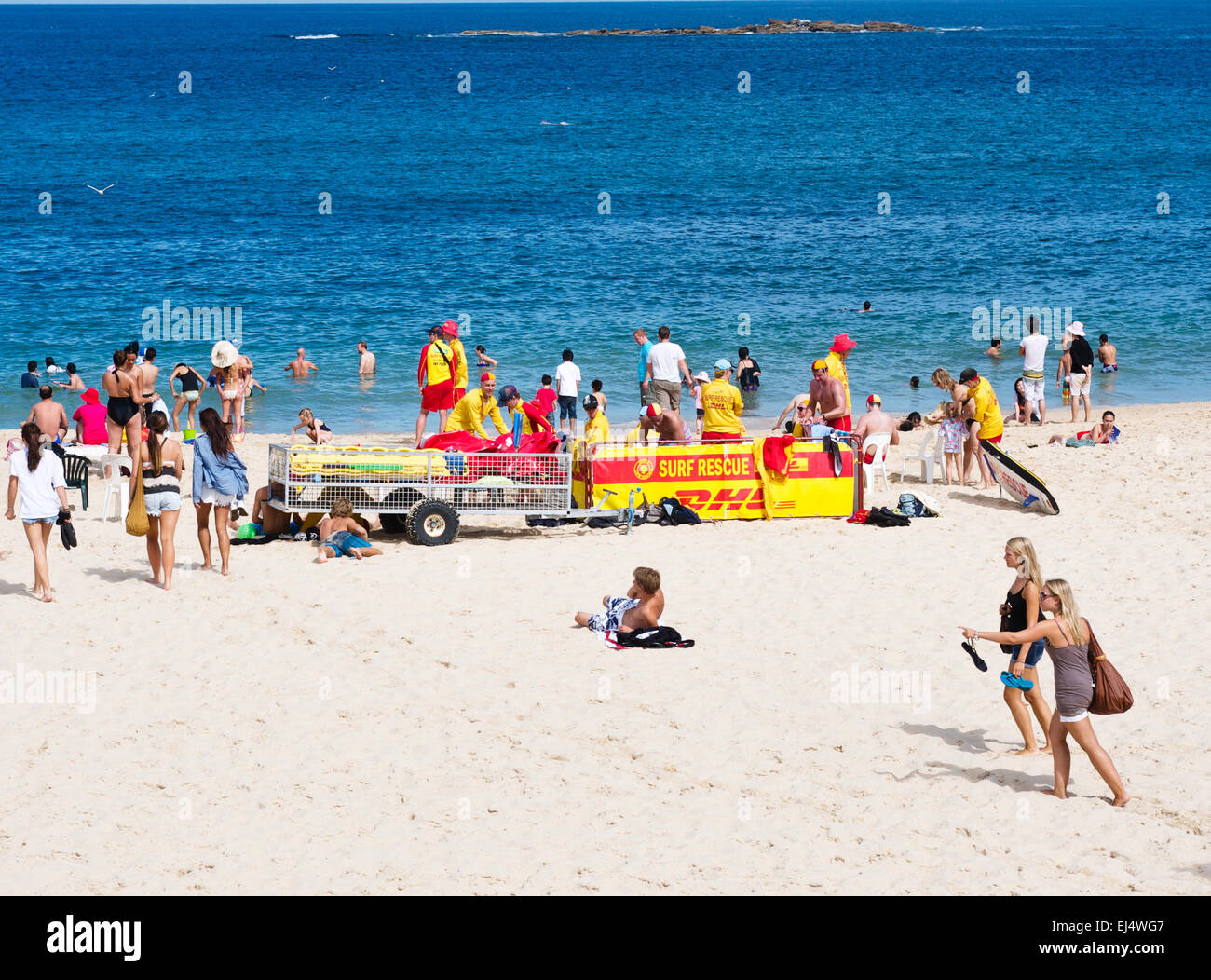 Swimmers, beach visitors, and surf lifesavers on a hot and sunny day by ...