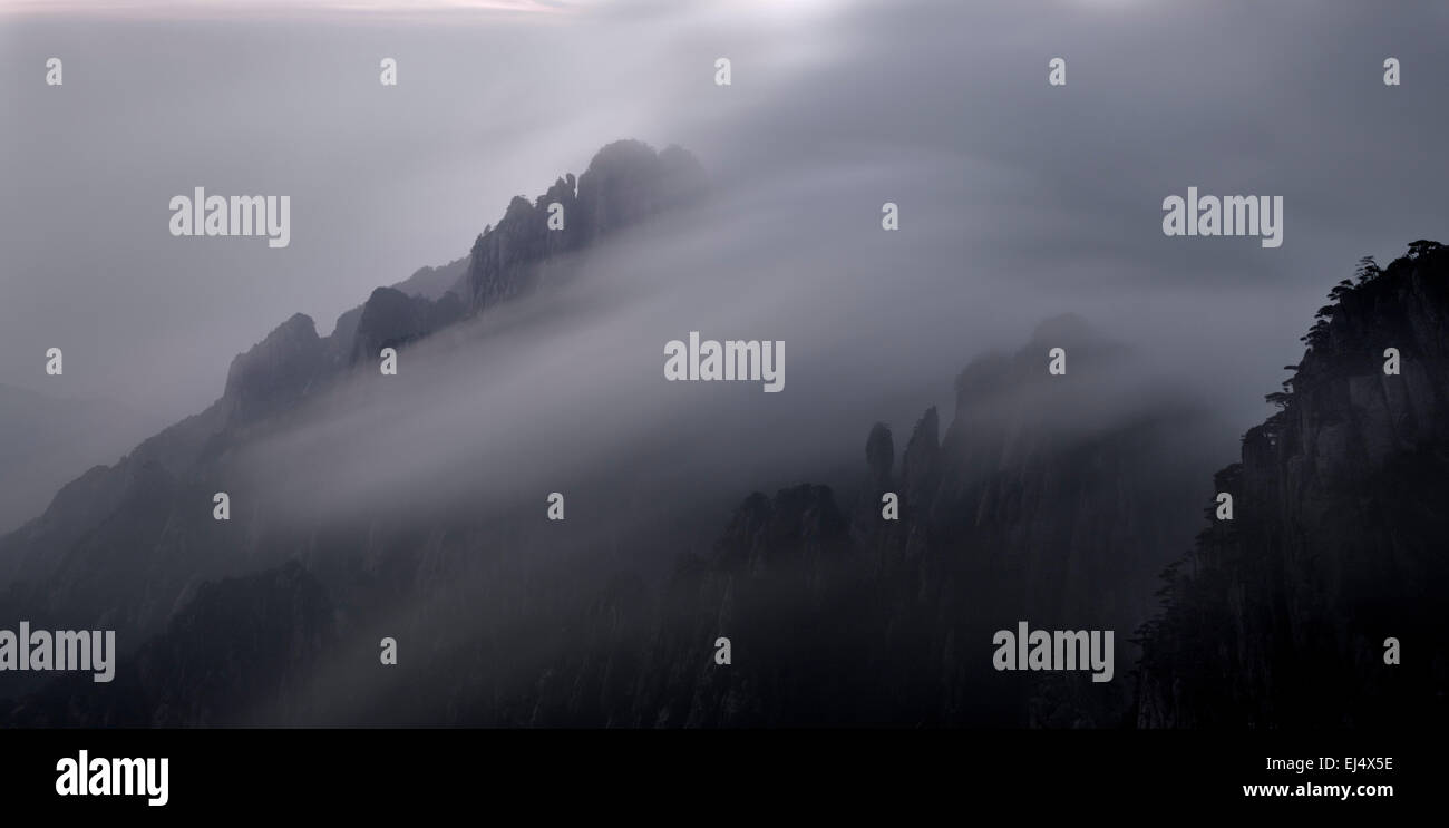 Cloud and mist rolling over mountain peaks in Mount Huangshan Scenic area, Huangshan, Anhui ...