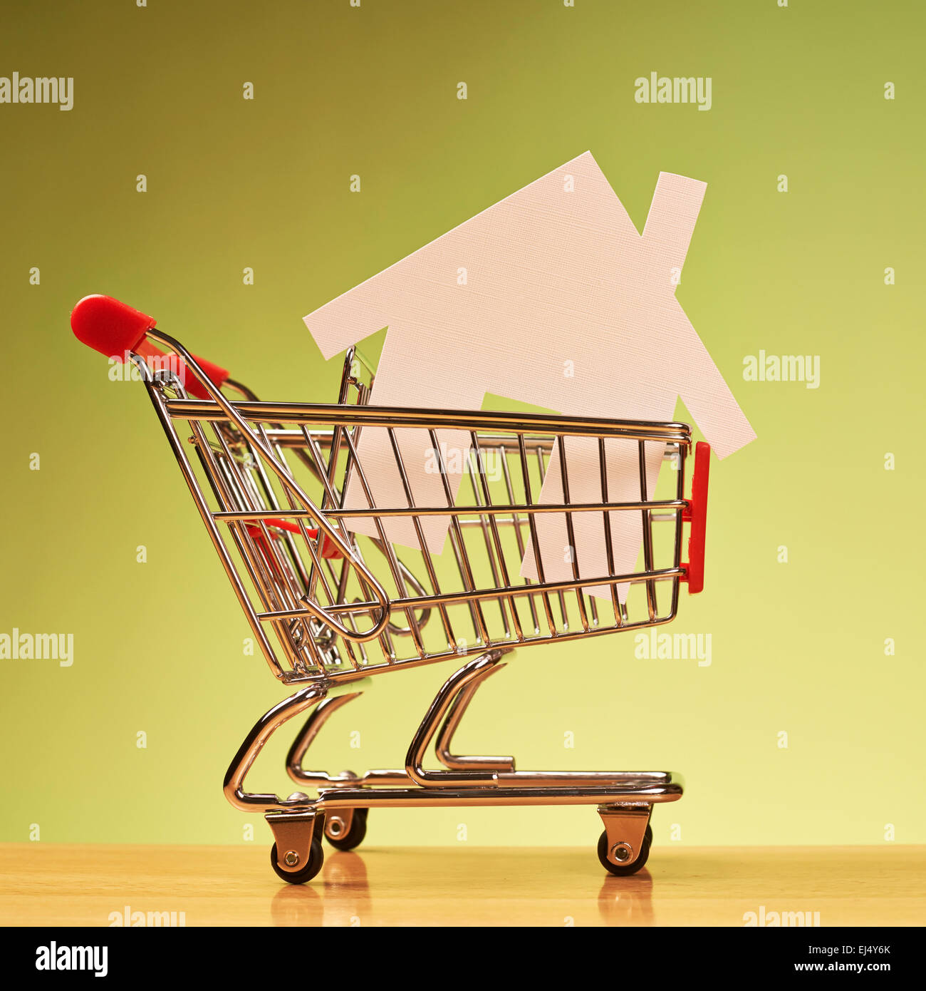 House shape inside shopping cart Stock Photo - Alamy