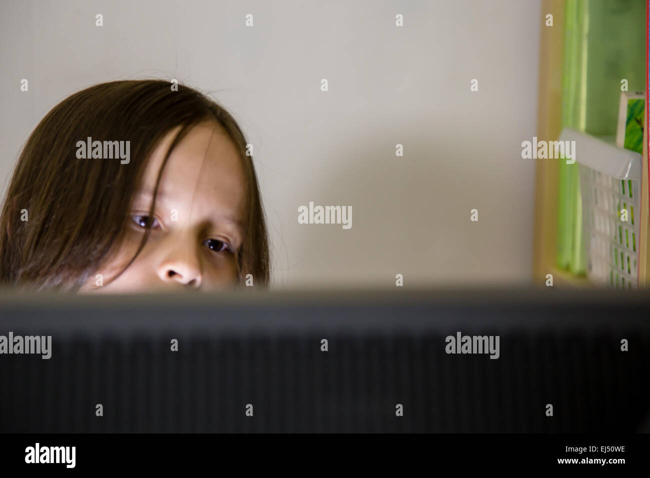 Young girl looking at computer screen Stock Photo - Alamy