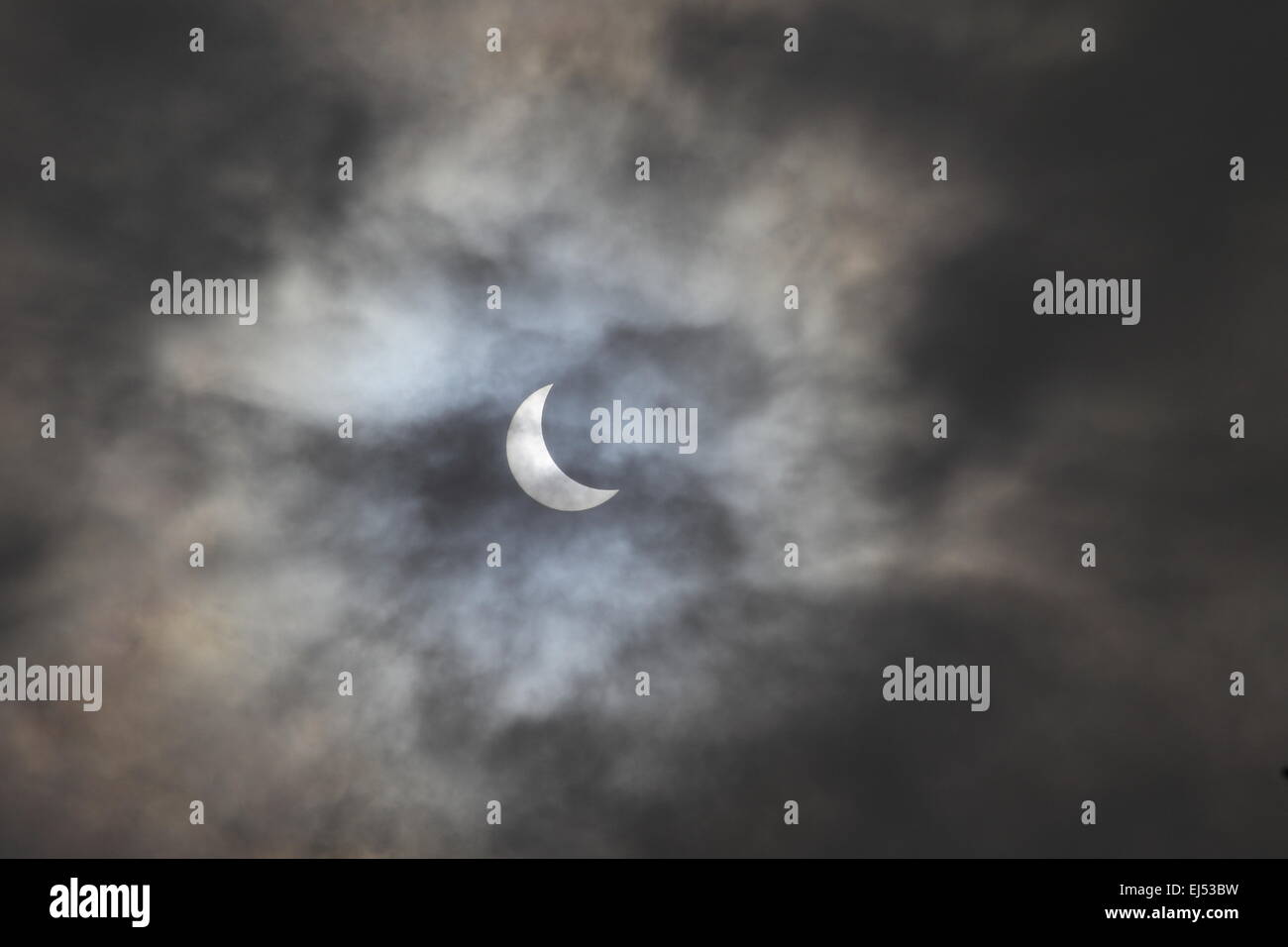 Partial solar eclipse through cloud Stock Photo - Alamy
