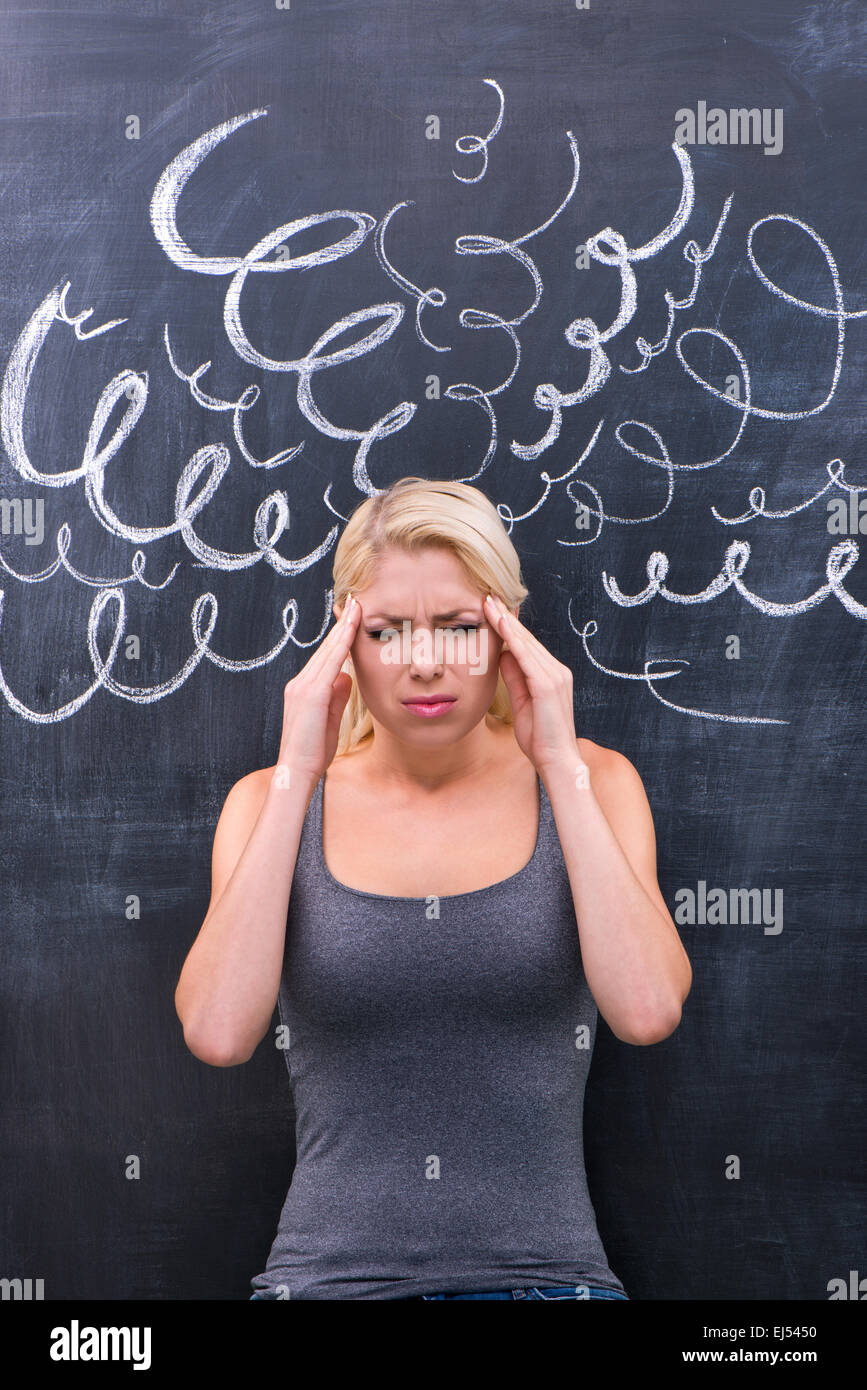 Overstressed blonde woman grab her head Stock Photo - Alamy