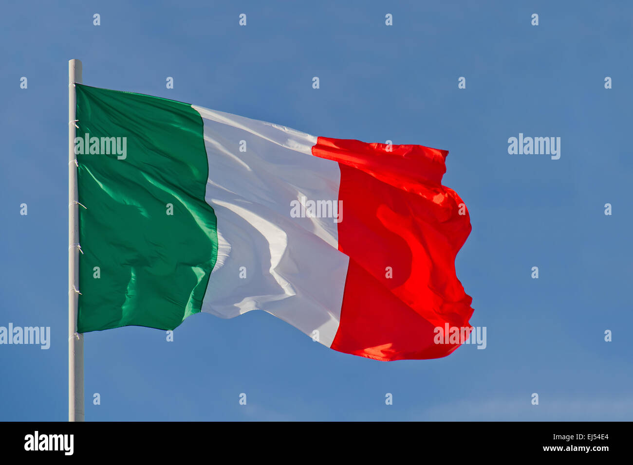 Italy flag is waving in front of blue sky Stock Photo - Alamy