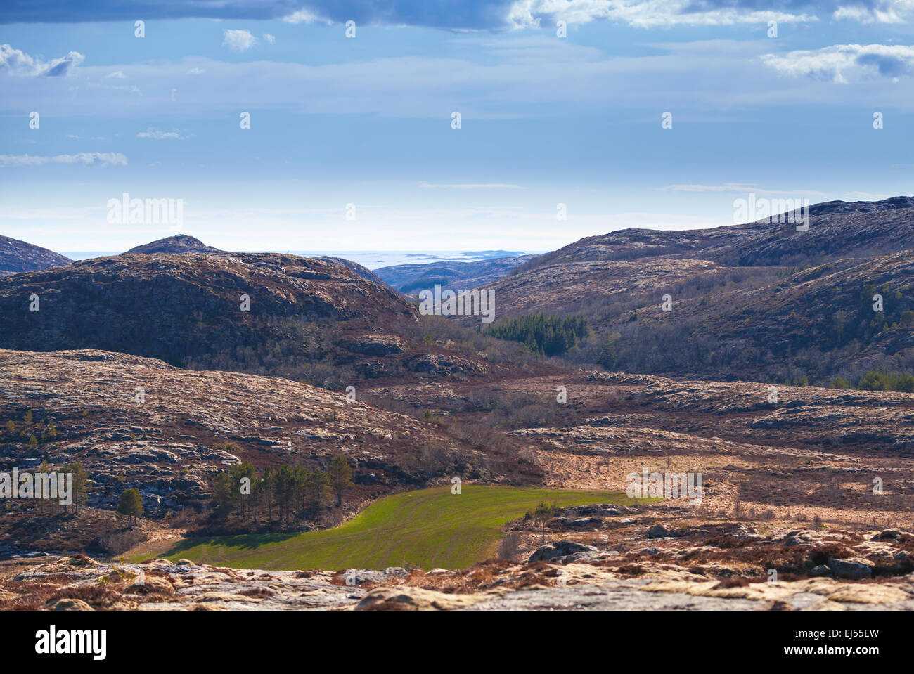 Norwegian spring landscape with dark mountains and green field Stock ...