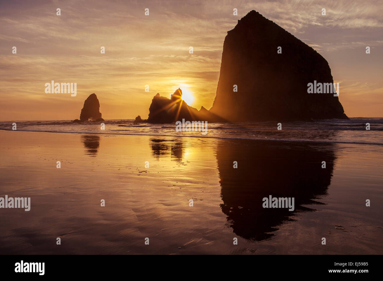 Sunset over Haystack Rock and other sea stacks at Cannon Beach, Oregon ...