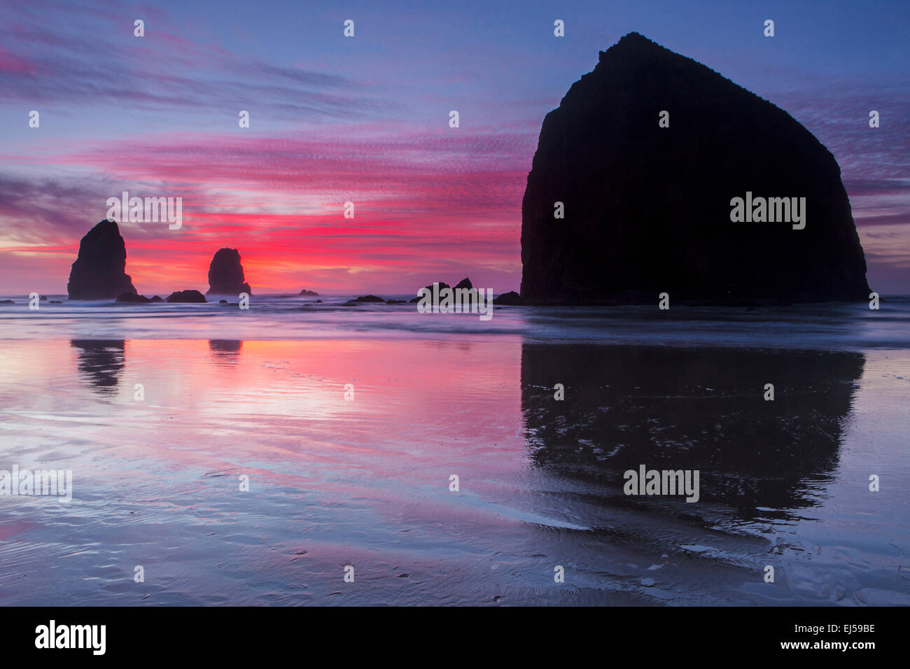 Sunset over Haystack Rock and other sea stacks at Cannon Beach, Oregon ...