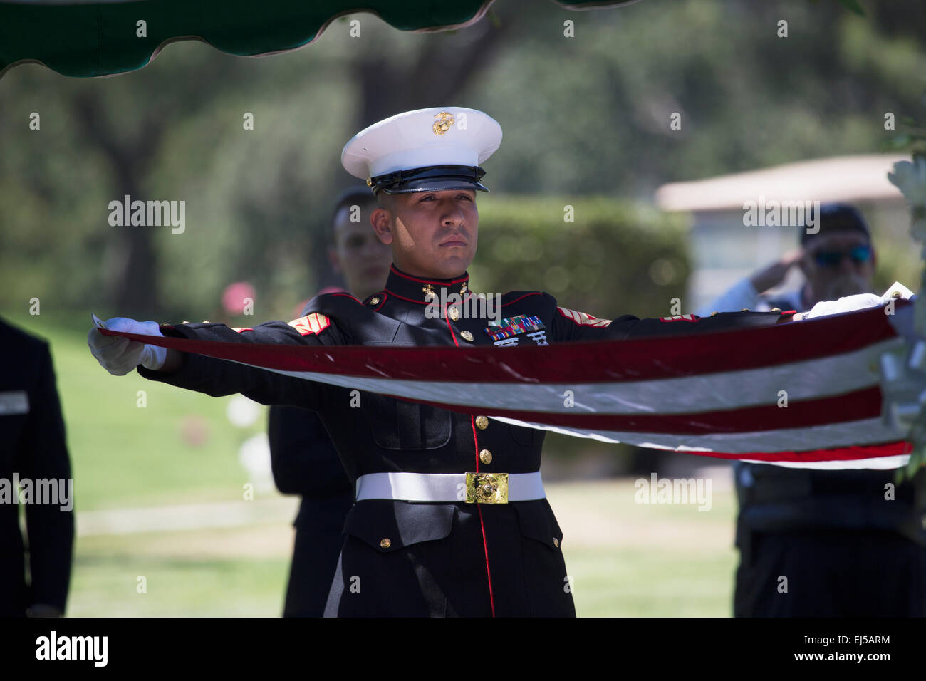 Marine folding flag at Memorial Service for fallen US Soldier, PFC Zach ...