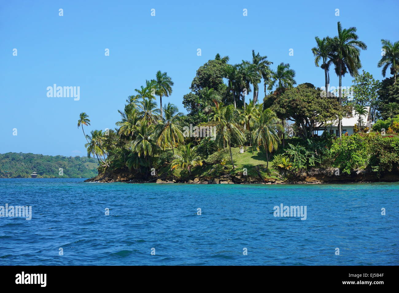Tropical island with beautiful vegetation and an house, viewed from the ...