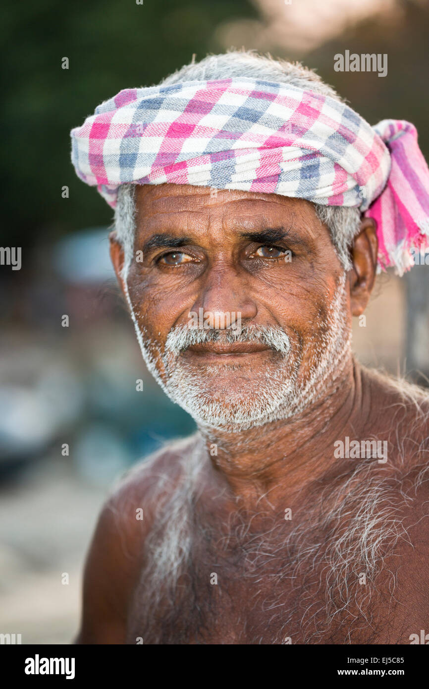 Keralan lifestyle: friendly local fisherman with chequered turban poses ...