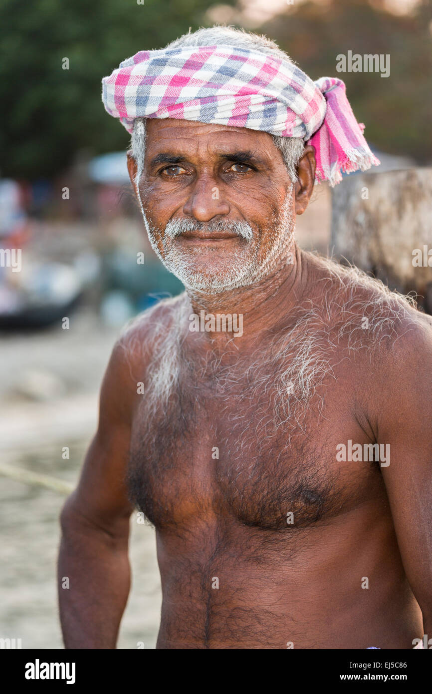 Keralan lifestyle: friendly local fisherman with chequered turban poses ...