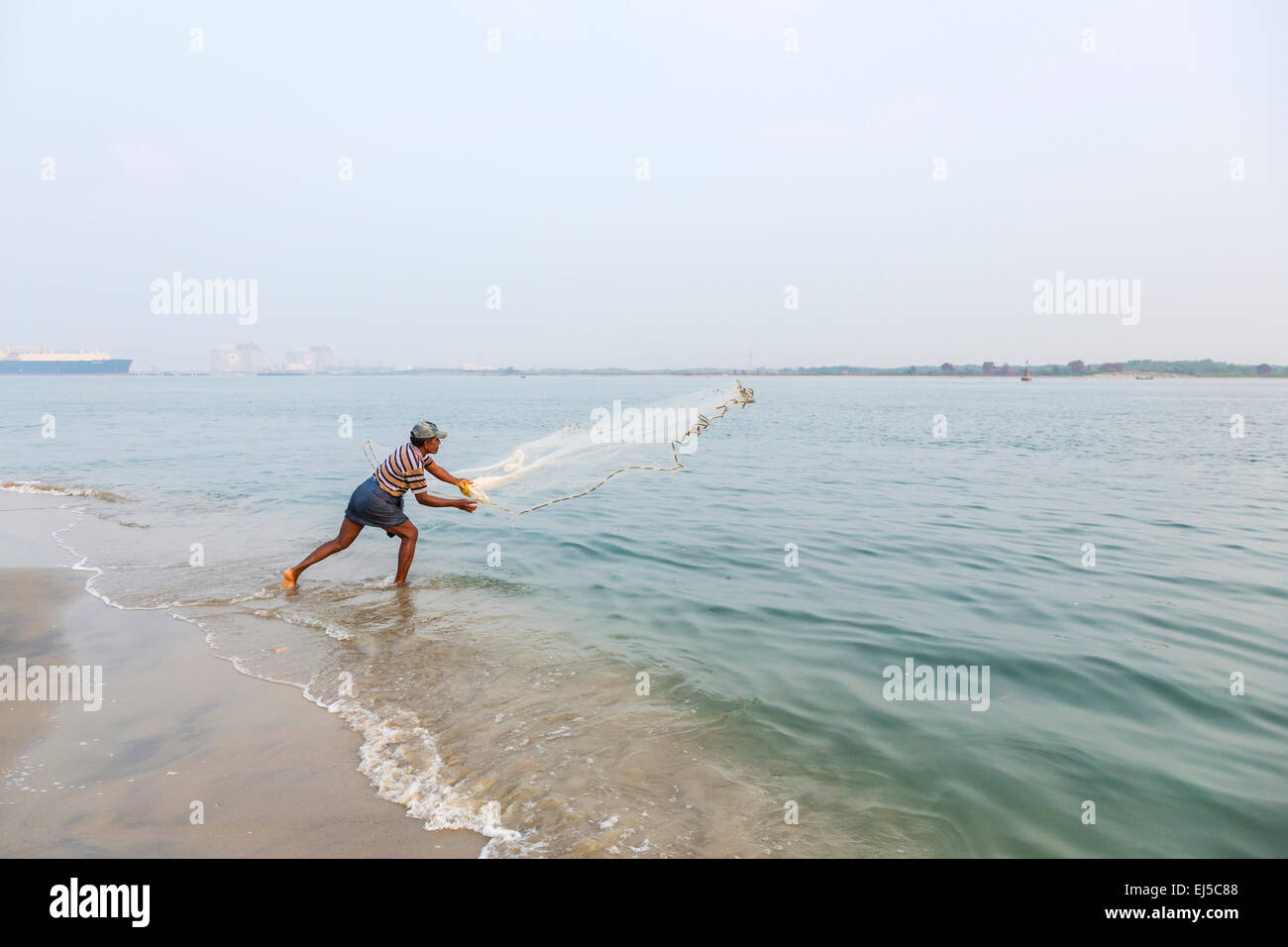 Local fisherman fishing from the shore using traditional methods ...