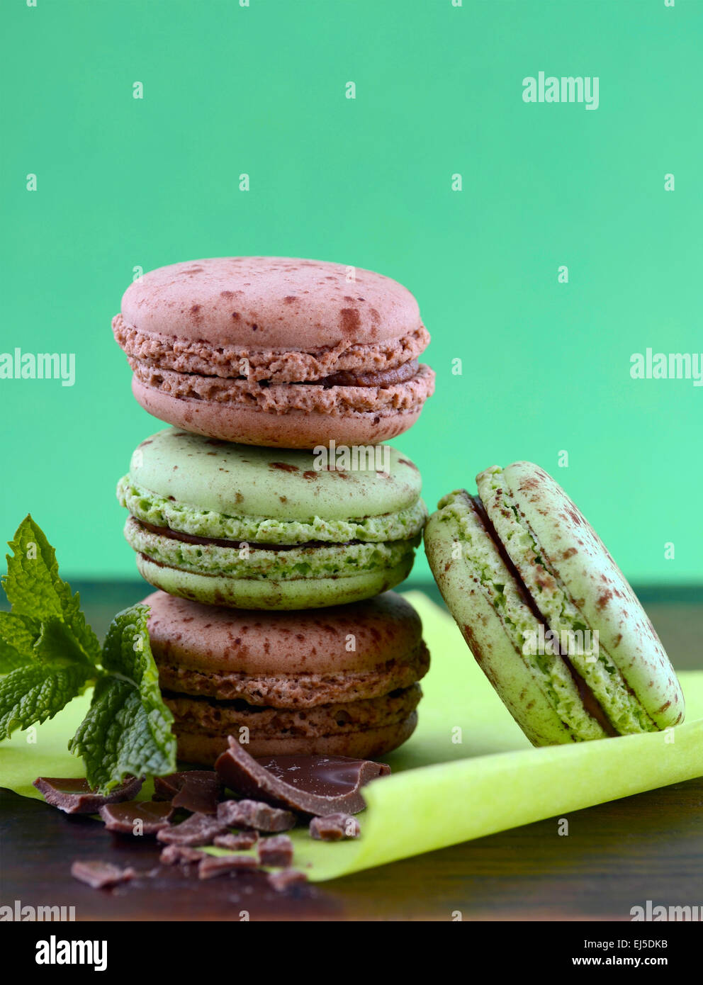 Chocolate and mint flavor macaroons on dark wood table and green ...