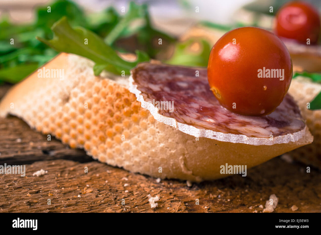 Spanish appetizer tapas, pintxos, pincho with arugula, cherry tomatoes ...