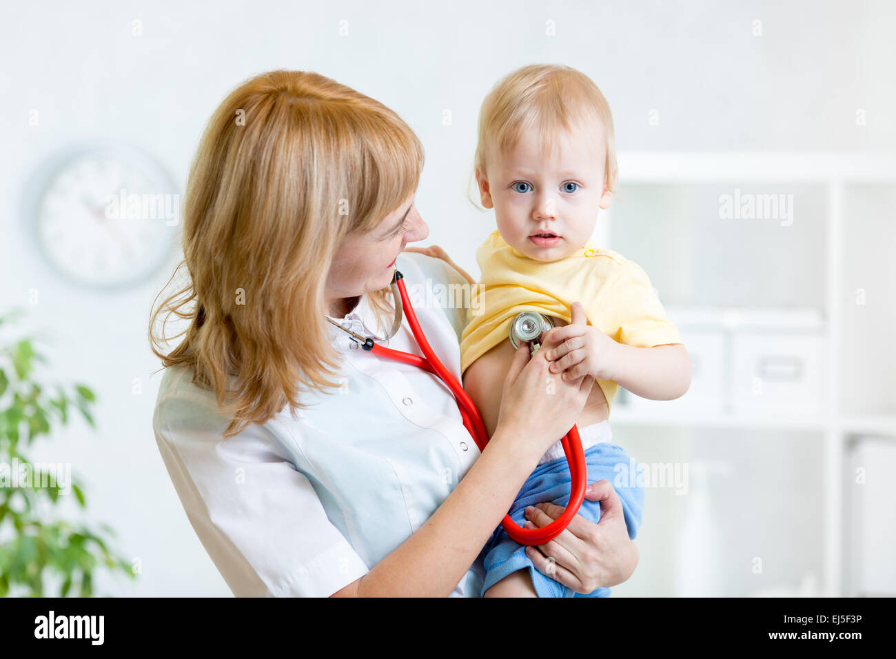 pediatrician examining heartbeat of kid with stethoscope Stock Photo ...