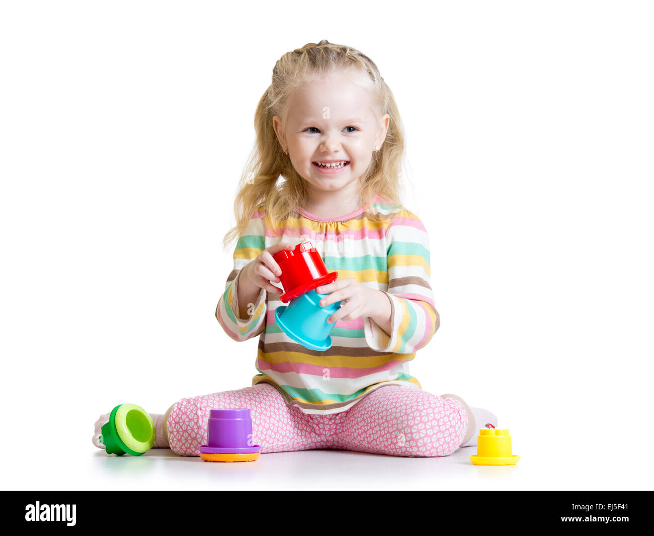 smiling child girl playing with color toys Stock Photo - Alamy