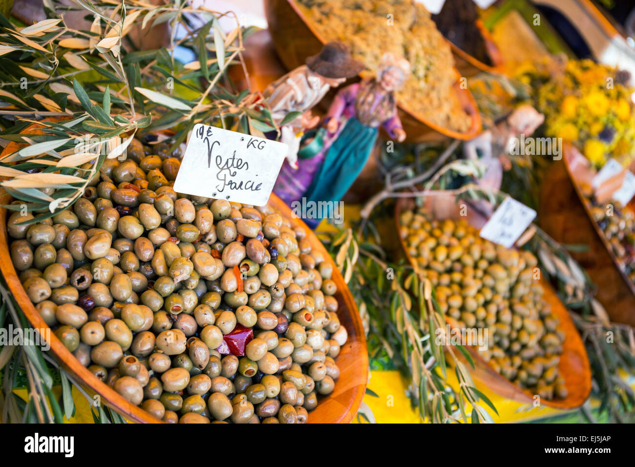 A variety of olives is being offered at a market stall at Beaune ...