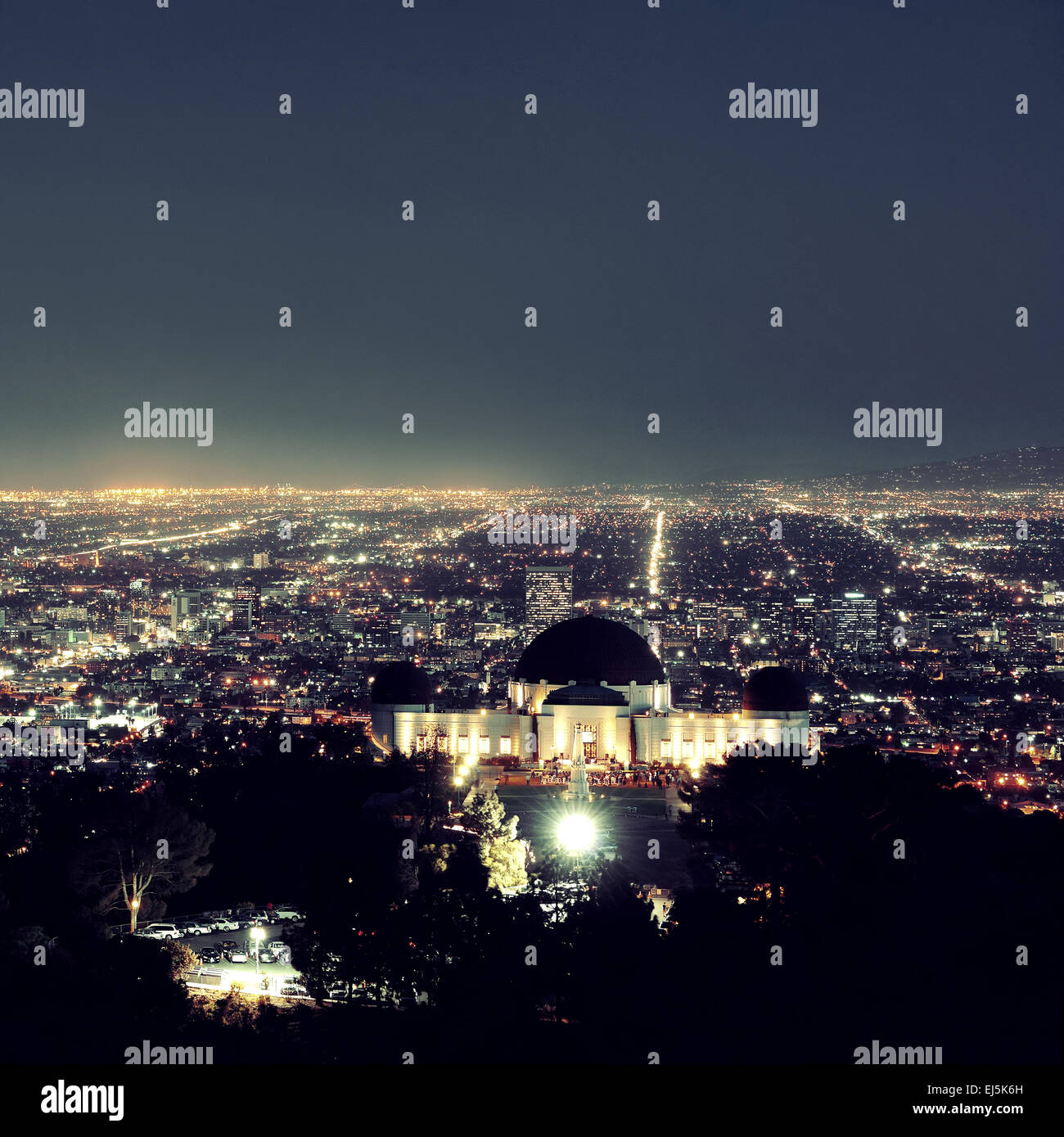 Los Angeles at night with urban buildings and Griffith Observatory ...